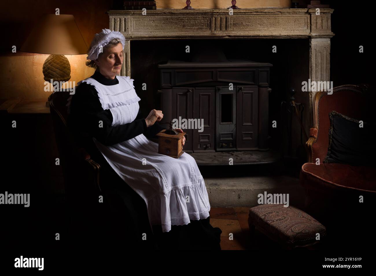 Victorian maid or servant in black dress, lace cap and white apron ...