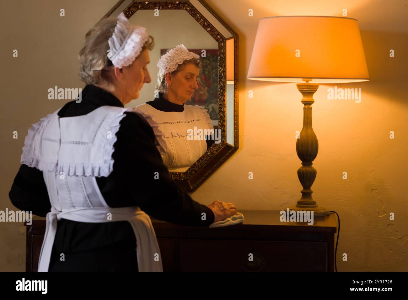 Victorian maid or servant in black dress, lace cap and white apron ...