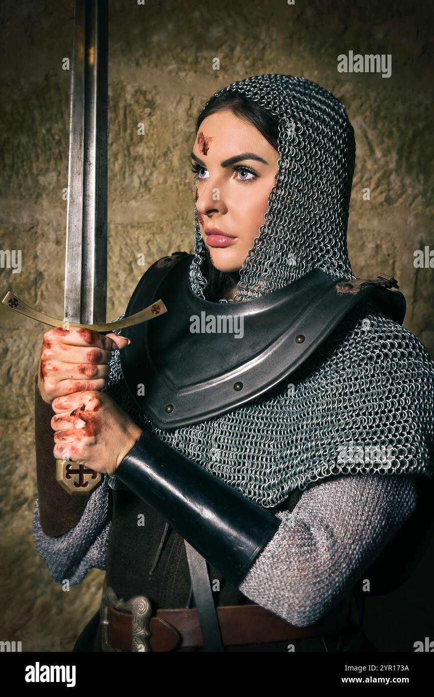 Reenactment scene of a female medieval knight in armor depicting the ...