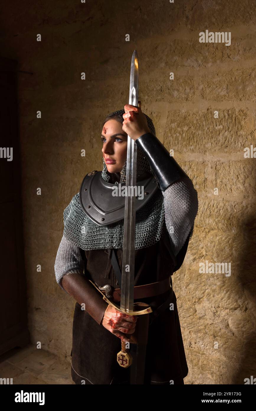 Young woman reenacting a female medieval knight wearing a leather tunic ...