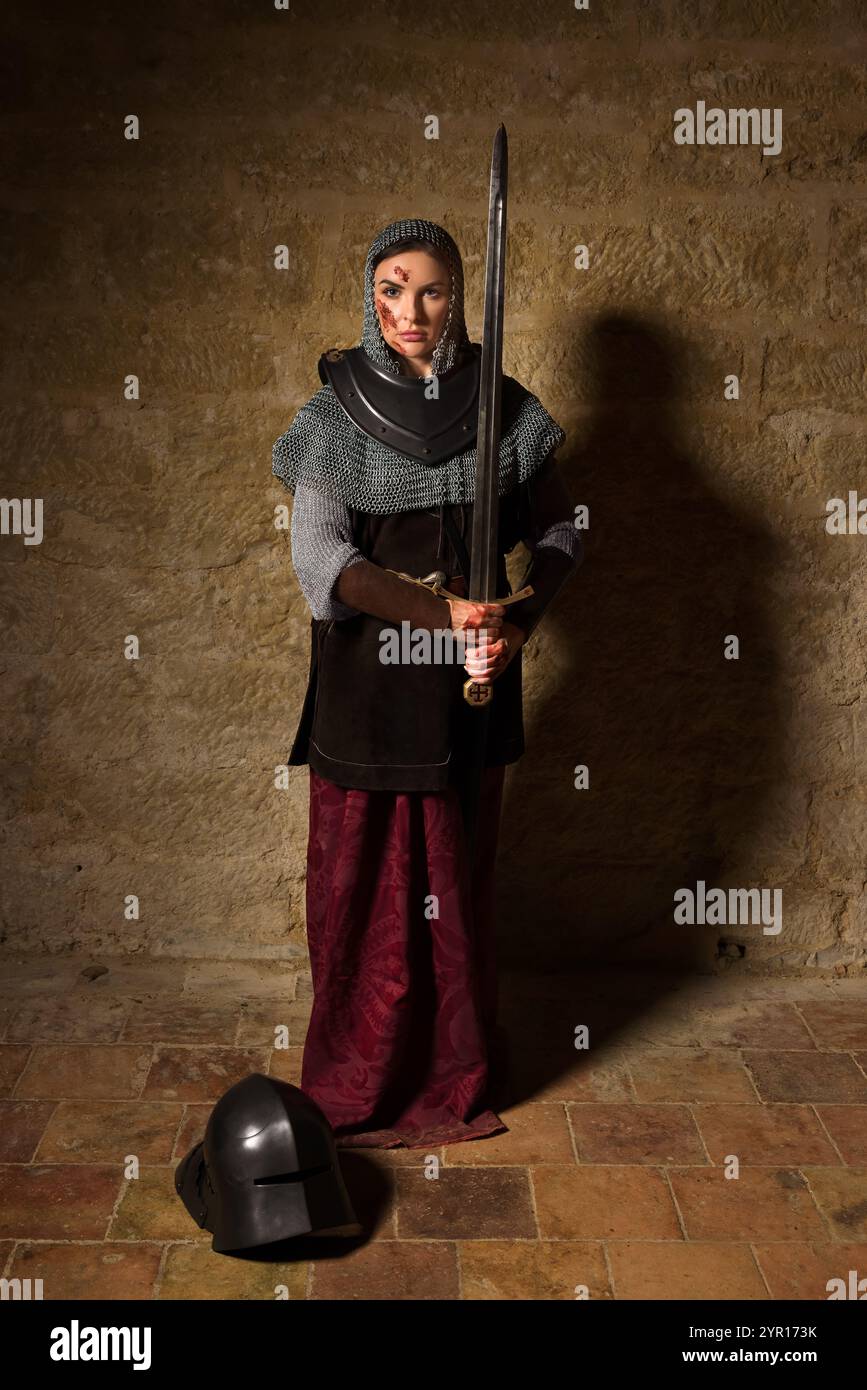Reenactment scene of a female medieval knight in armor depicting the ...