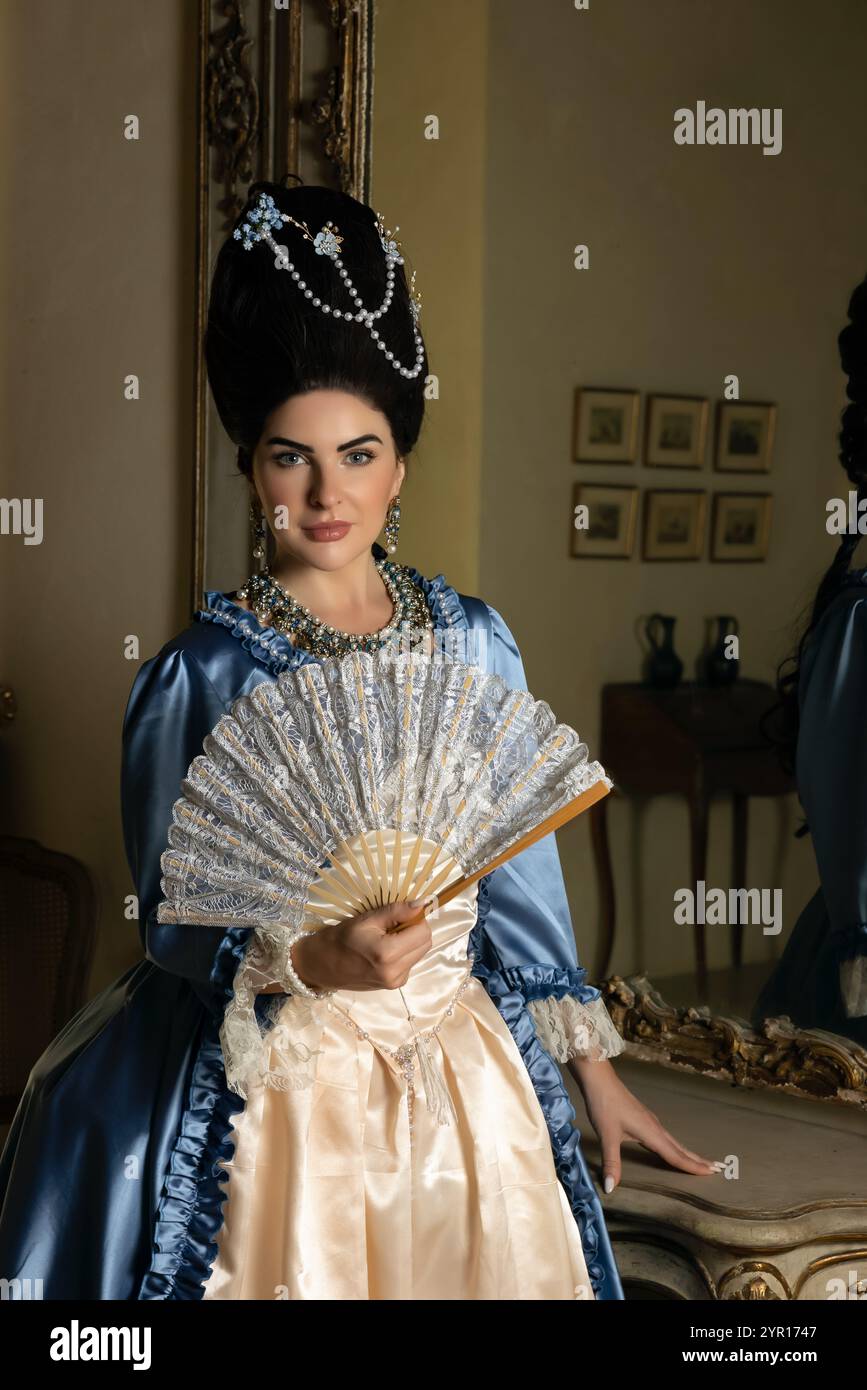 Beautiful young woman dressed in rococo queen Marie Antoinette style ...