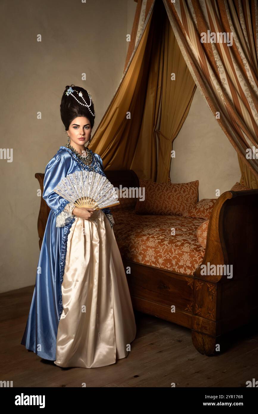 Beautiful young woman dressed in rococo queen Marie Antoinette style ...