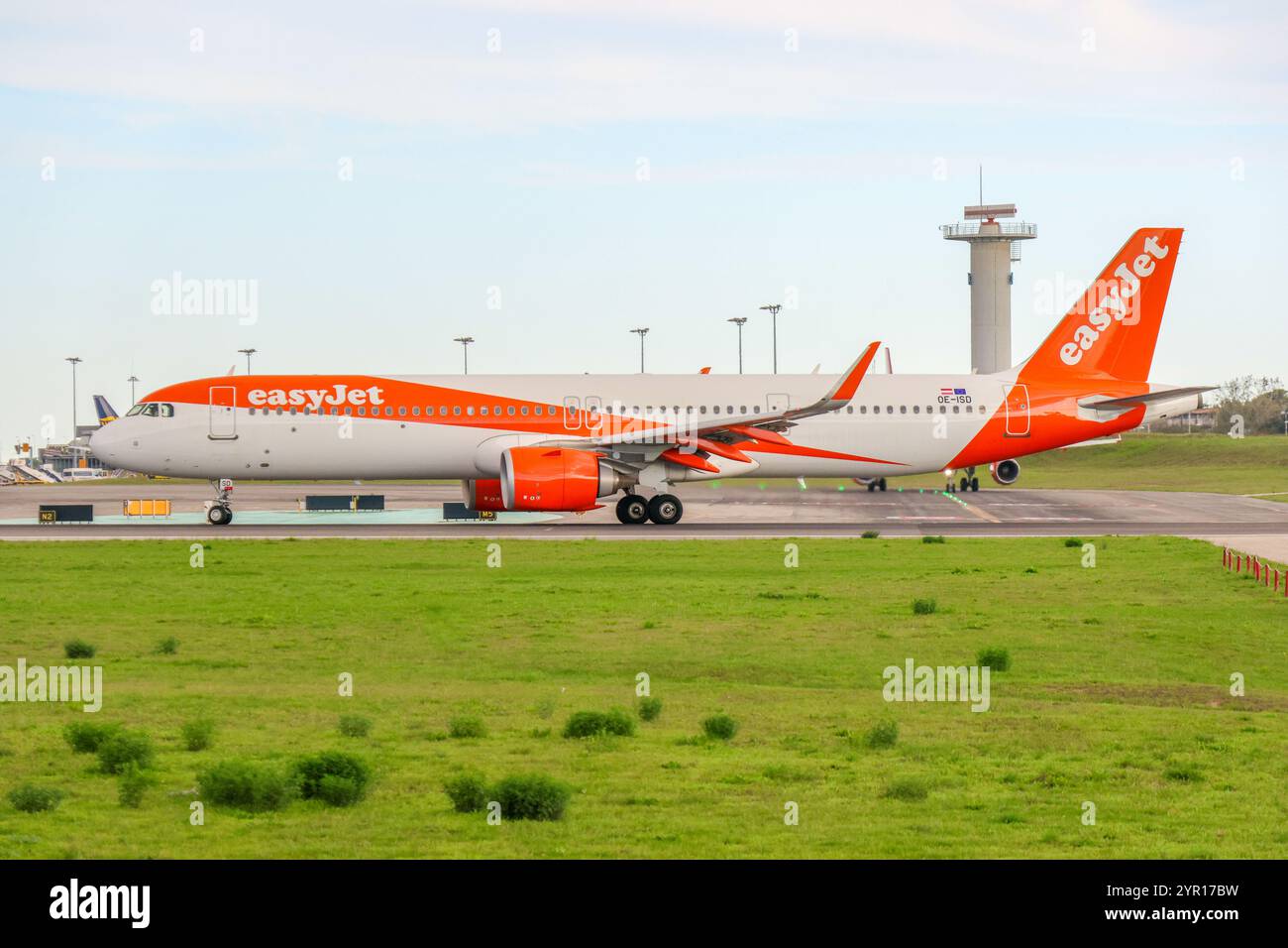 Orange easyjet airbus a320neo taxiing on the runway of lisbon humberto ...