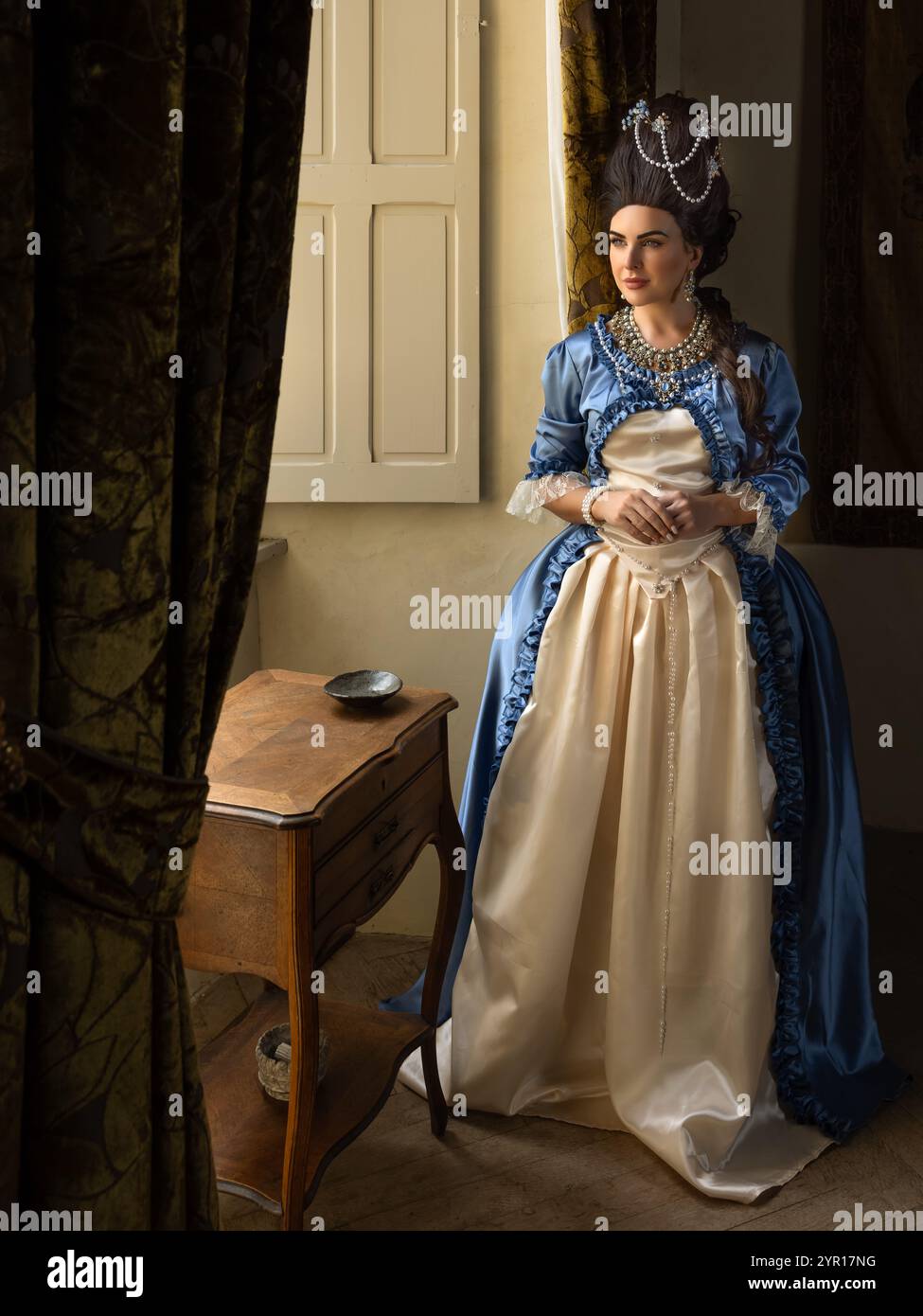 Beautiful young woman dressed in rococo queen Marie Antoinette style ...