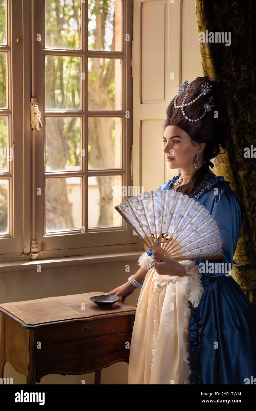Beautiful young woman dressed in rococo queen Marie Antoinette style ...