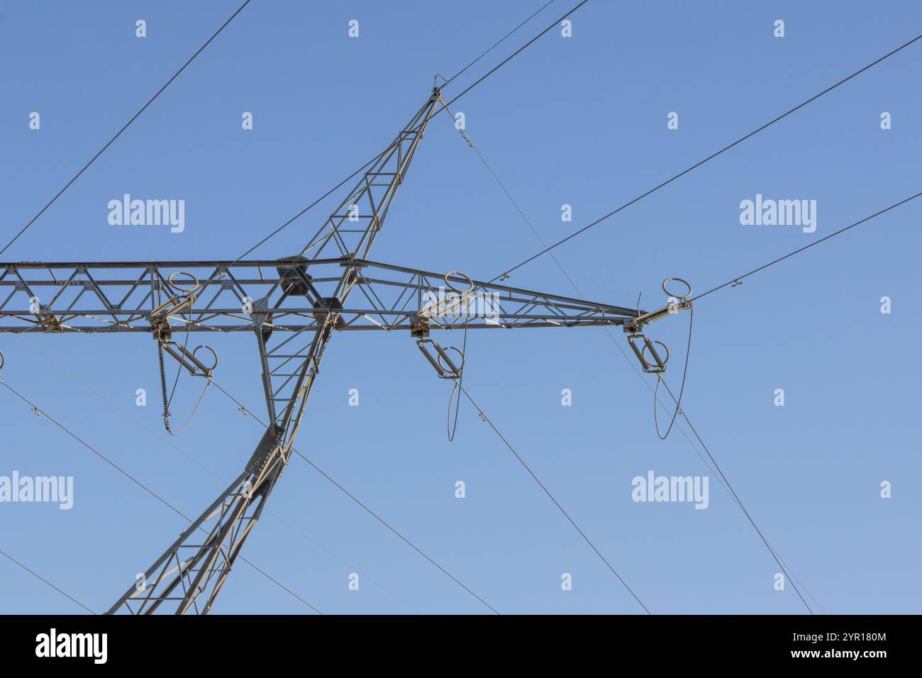 Metal electricity pylon carrying high voltage power cables against a ...