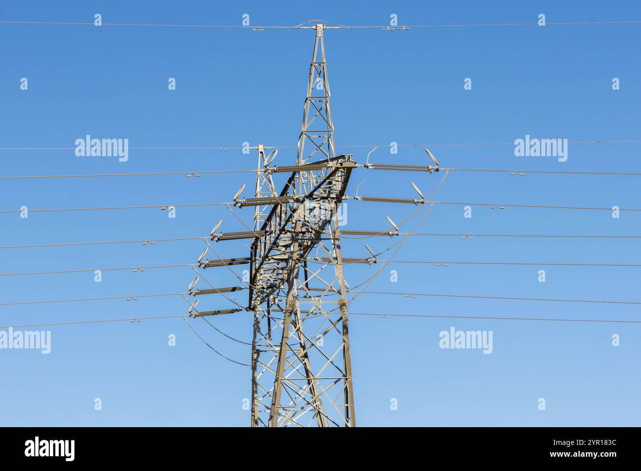 Metal electricity pylon carrying power supply cables across a clear ...