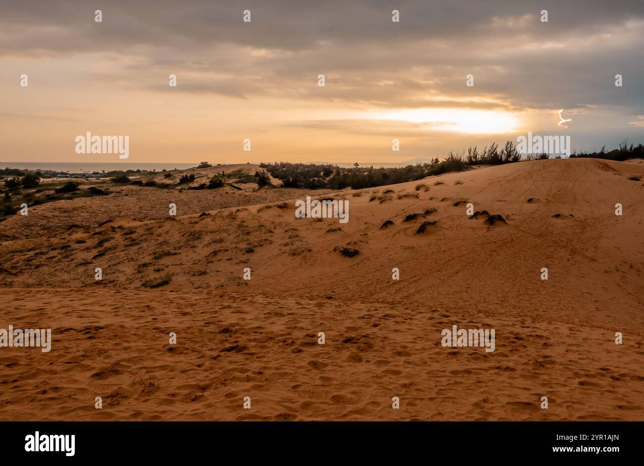 The stunning red sand dunes in Mui Ne, Vietnam at sunset Stock Photo ...
