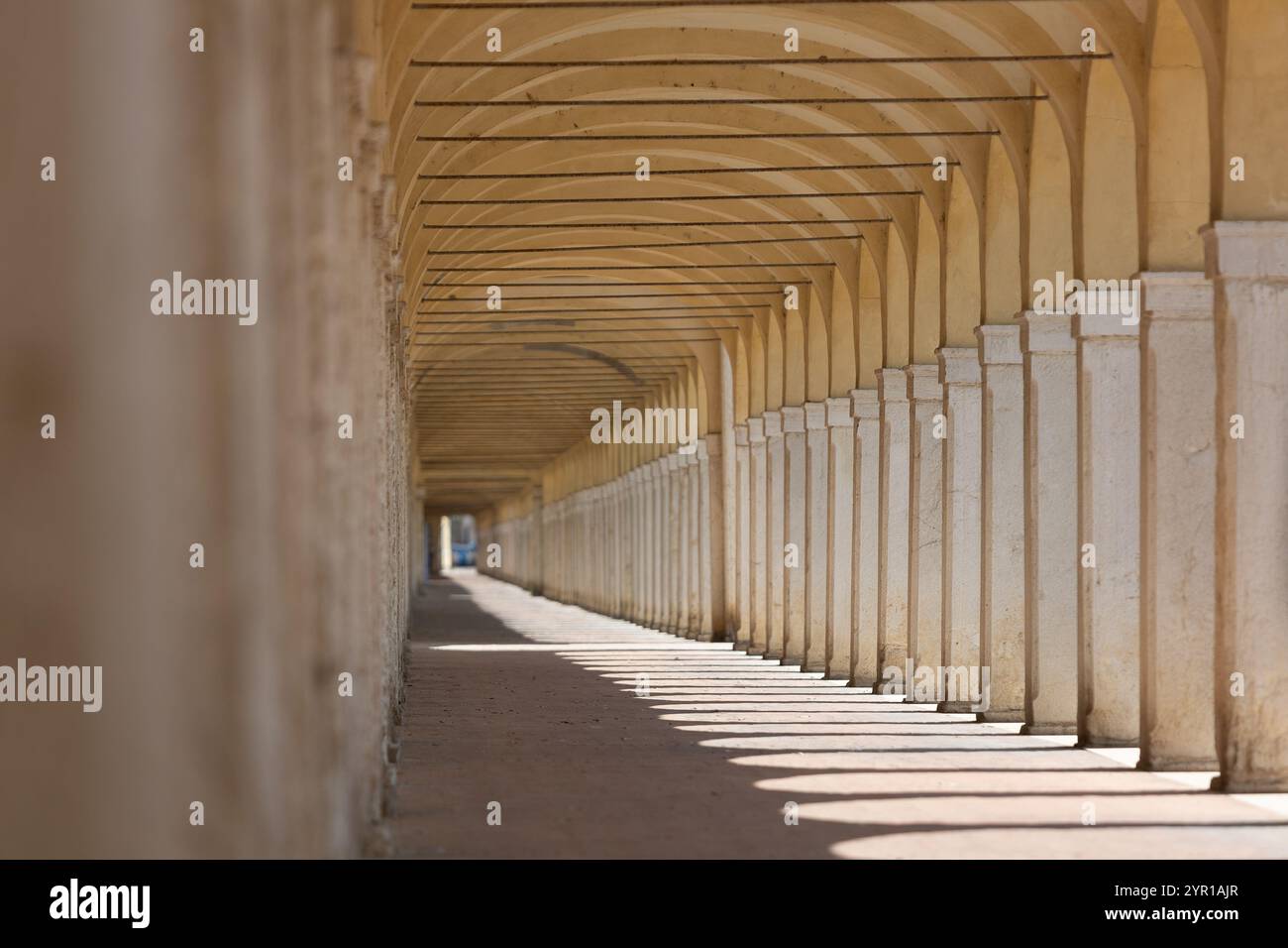 Architectural perspective of a long covered walkway with columns and ...
