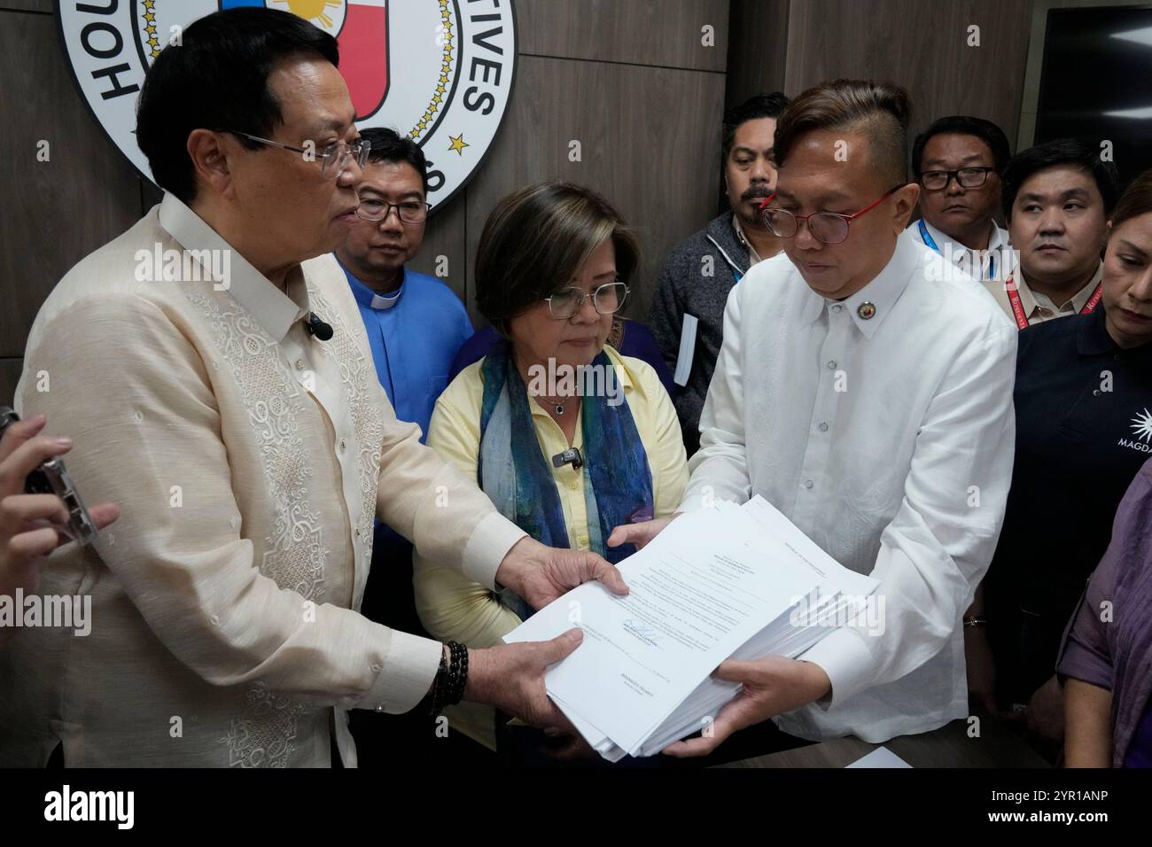 House Secretary General, Reginald Velasco, left, receives an ...