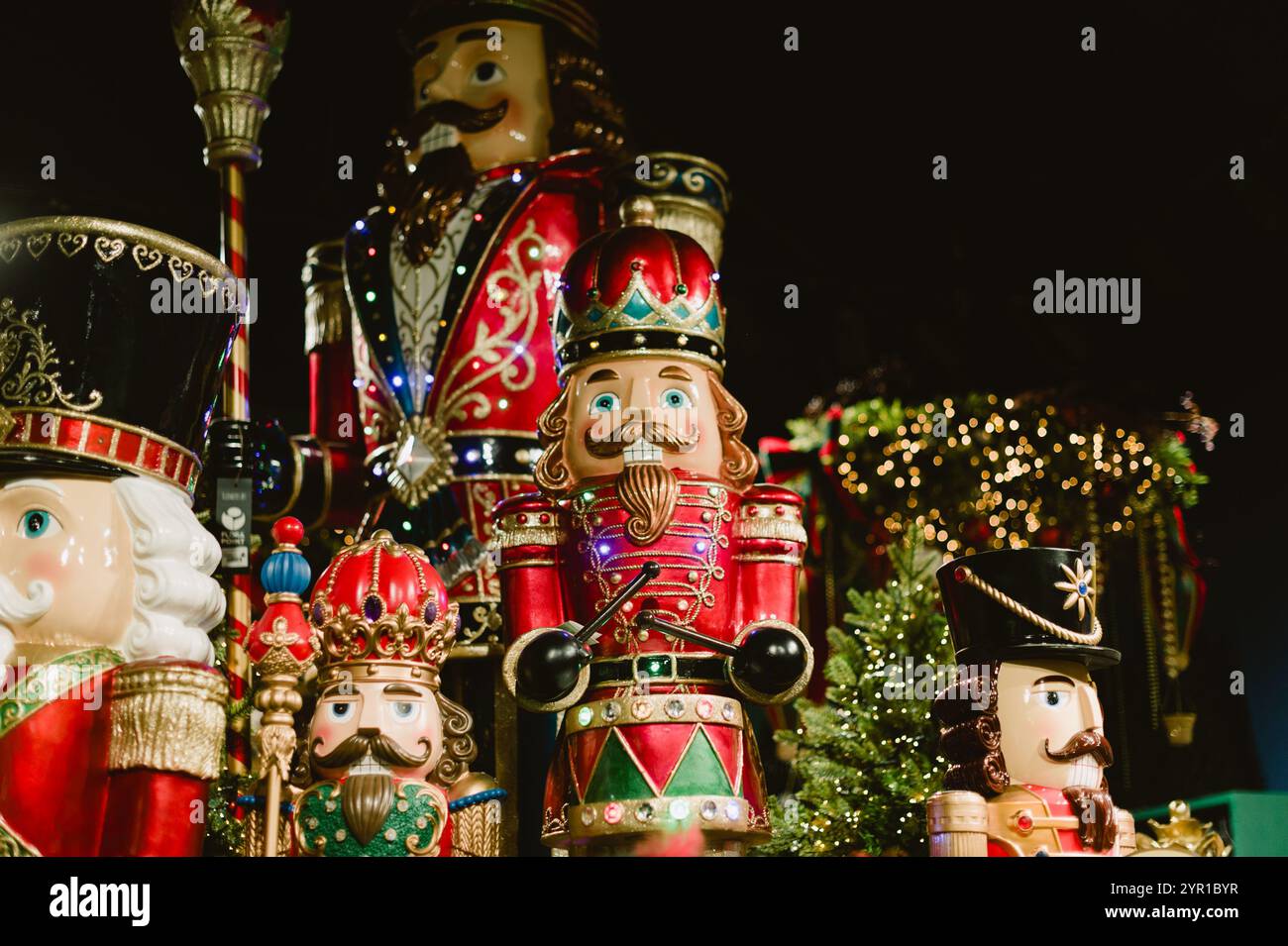 A large display of nutcrackers with a Merry Christmas sign. There are ...