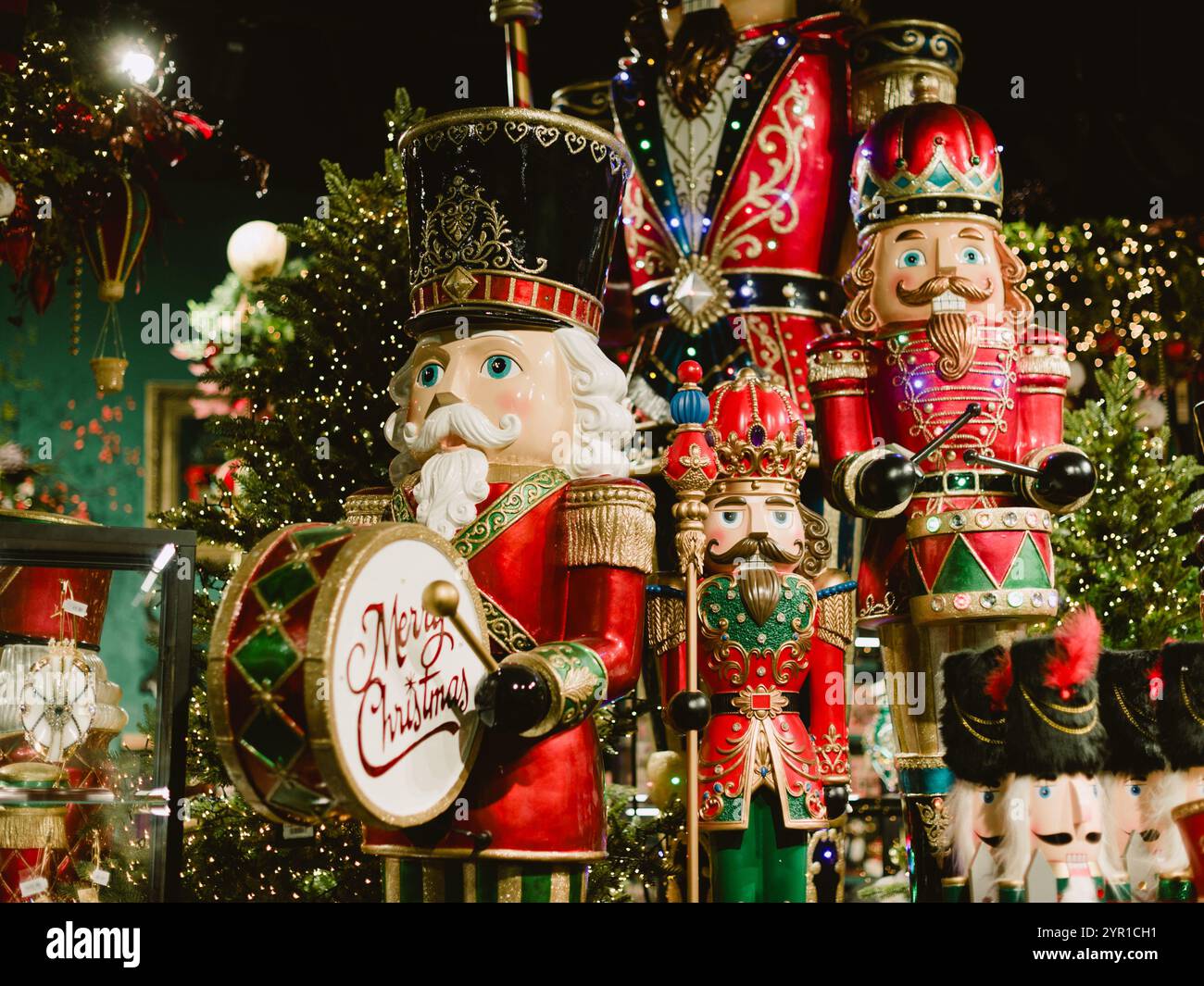 A large display of nutcrackers with a Merry Christmas sign. There are ...