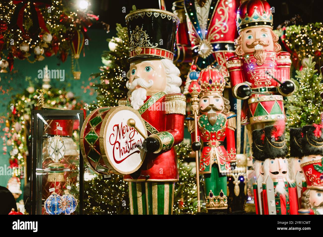 A large display of nutcrackers with a Merry Christmas sign. There are ...