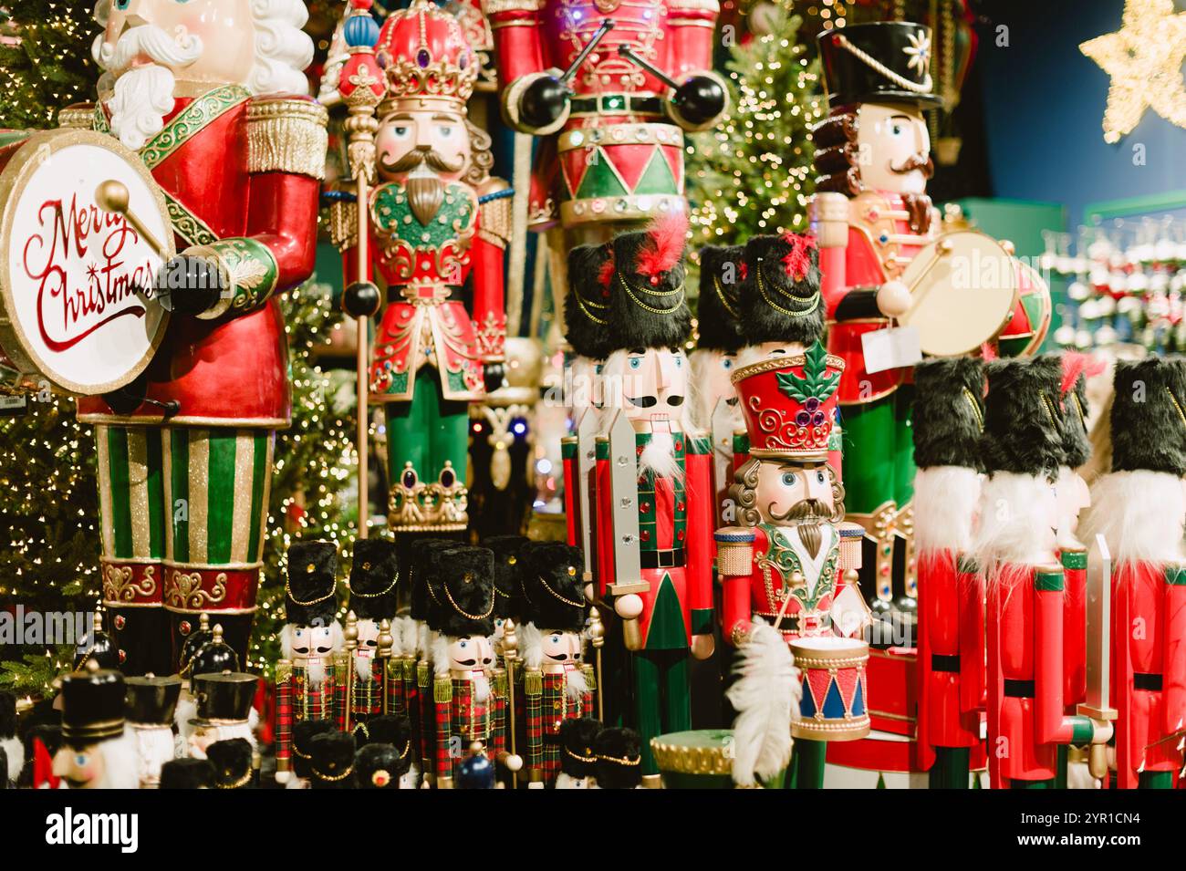A large display of nutcrackers with a Merry Christmas sign. There are ...