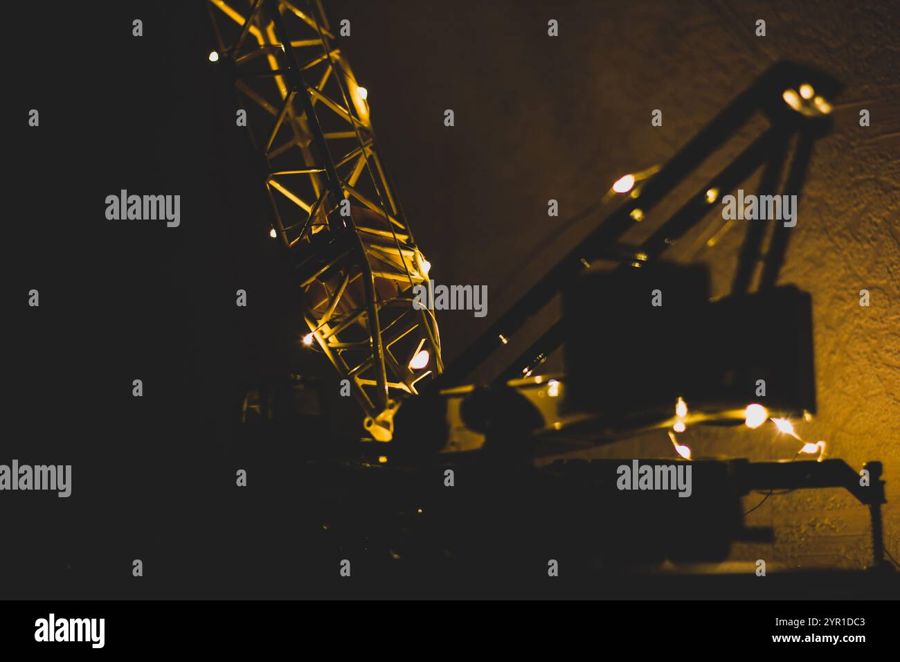 Big boom crane with light lights in the dark Stock Photo - Alamy