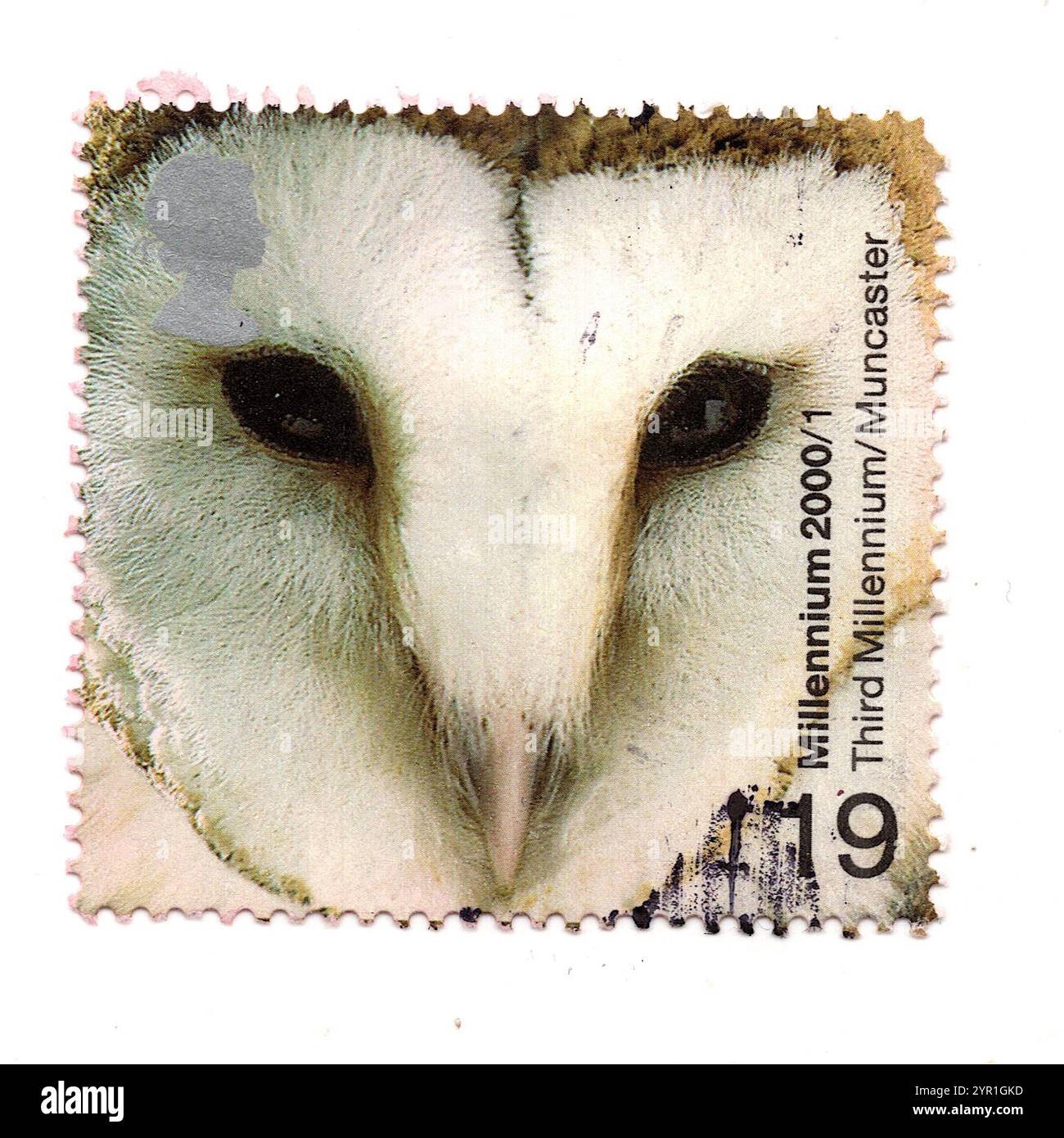 A vintage postage stamp from Great Britain featuring the face of an owl ...