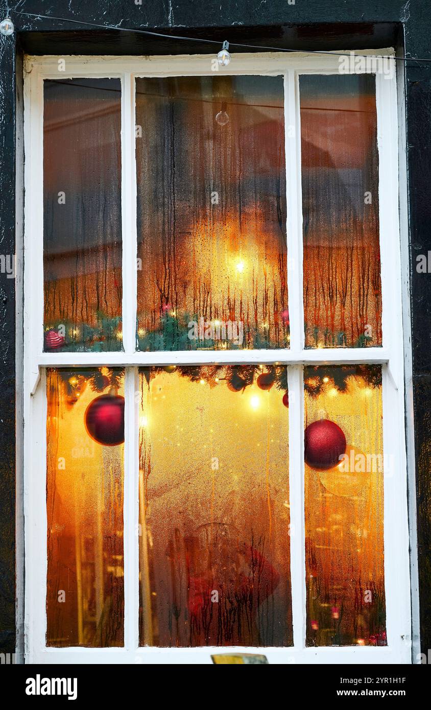 Christmas decorations in pub window at dusk Stock Photo - Alamy
