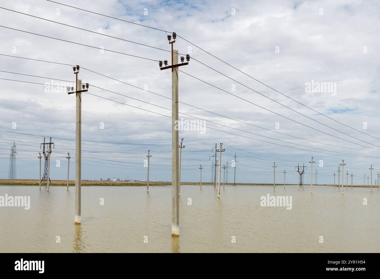 Power lines are partially submerged in water, creating a striking ...