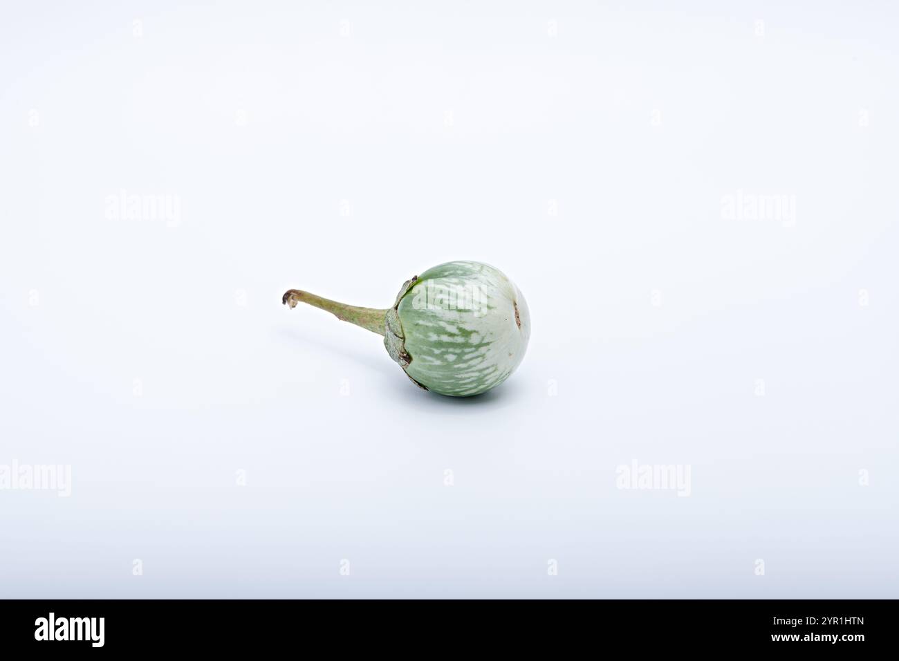 Healthy green round mini eggplant vegetable photographed with white ...