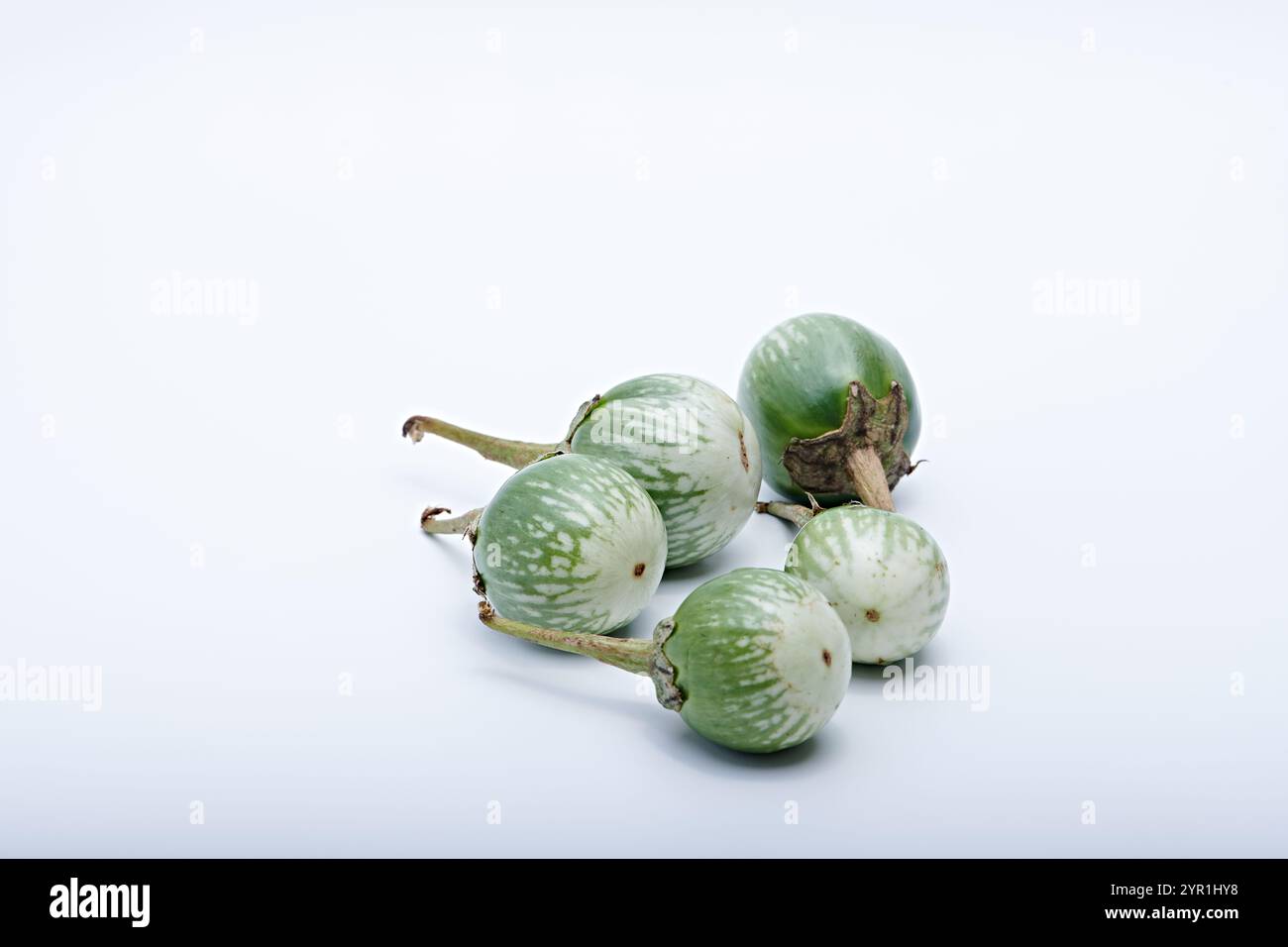 Healthy green round mini eggplant vegetable photographed with white ...