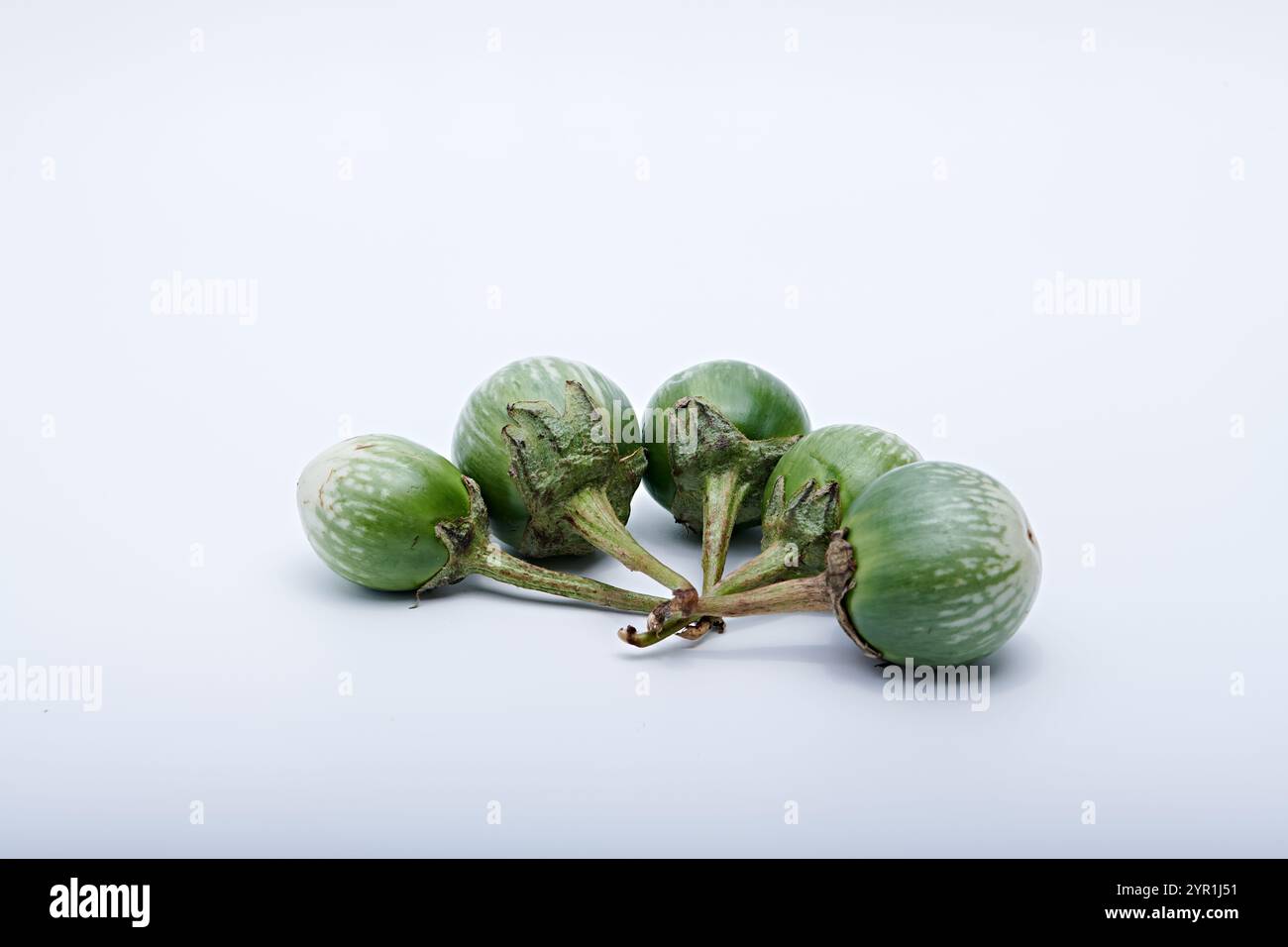 Healthy green round mini eggplant vegetable photographed with white ...
