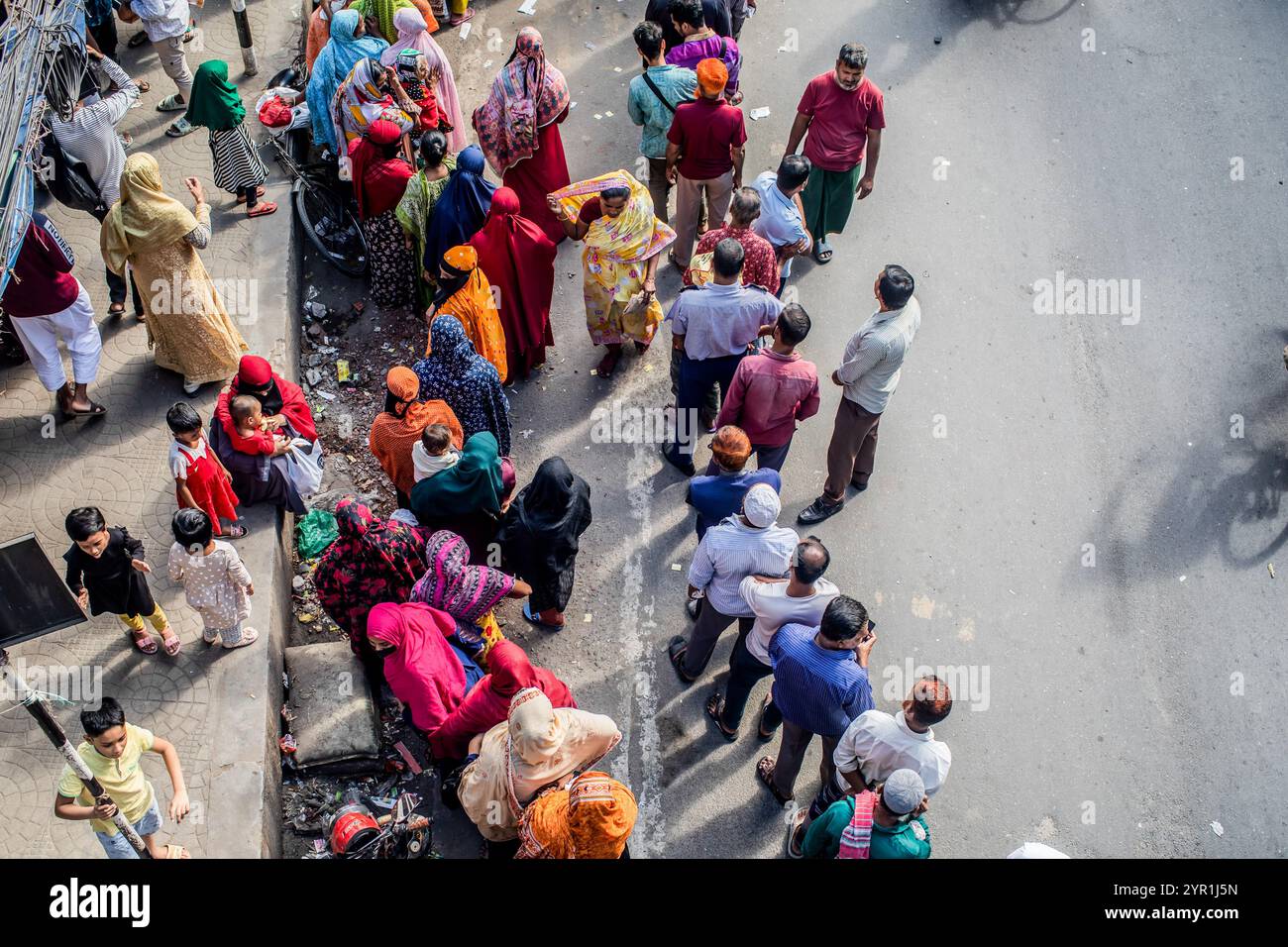 People in a queue wait to buy daily essentials at subsidized prices ...