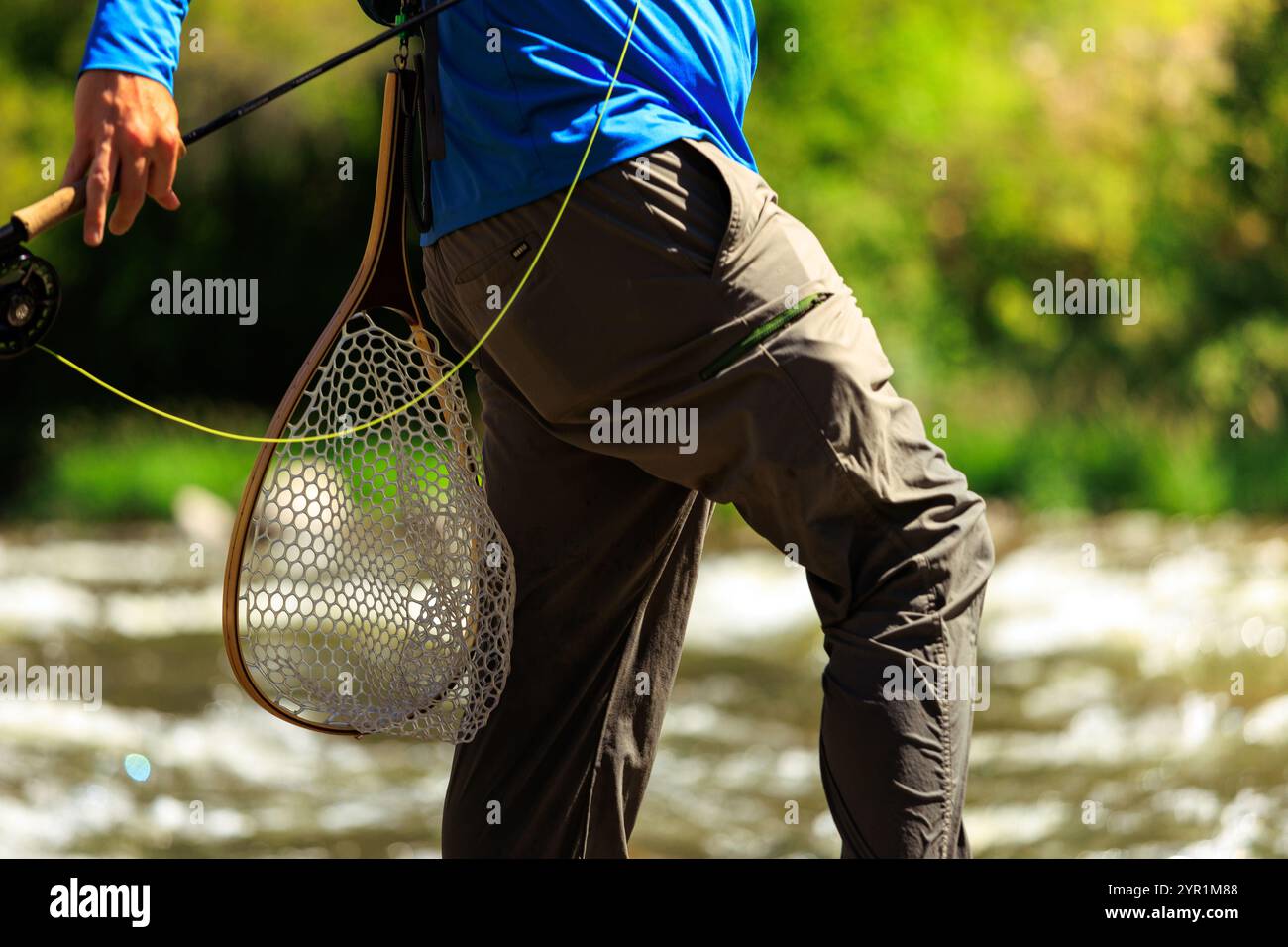 Man holds Fly Fishing Net and Rod Stock Photo - Alamy