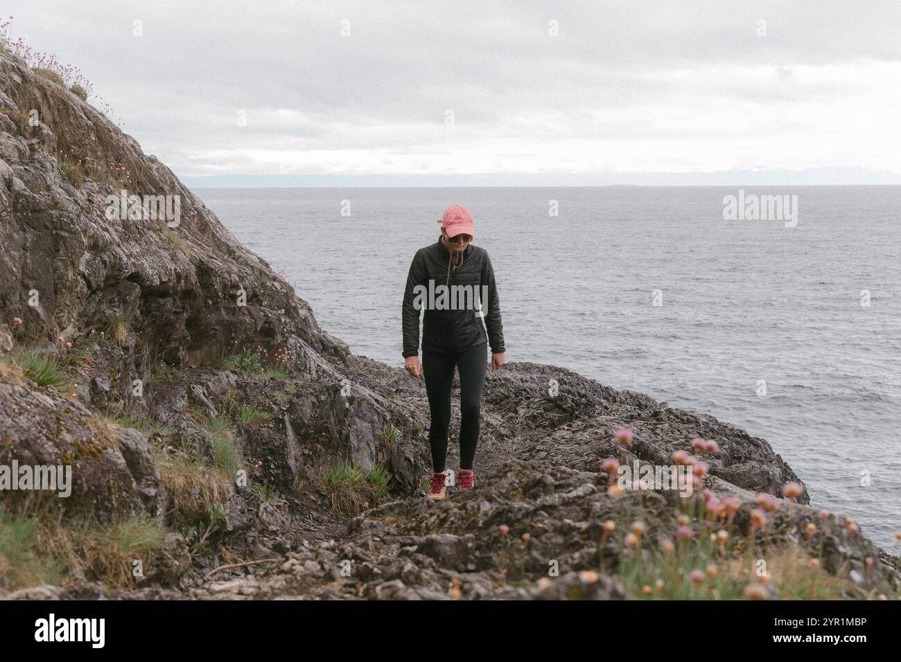 Female hiking up cliff with Puget Sound in background Stock Photo - Alamy