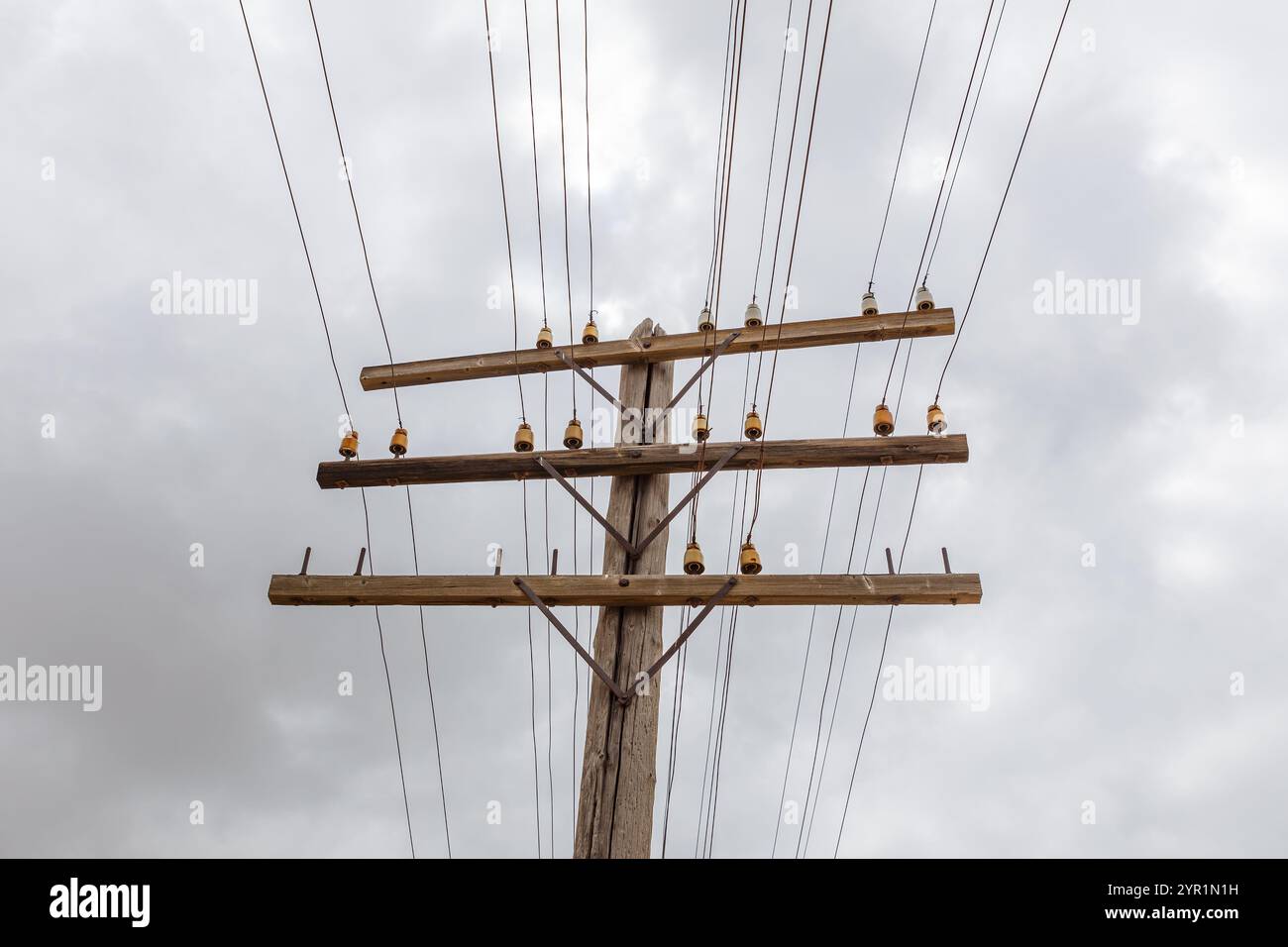 The overhead communication line stretches between utility poles under a ...