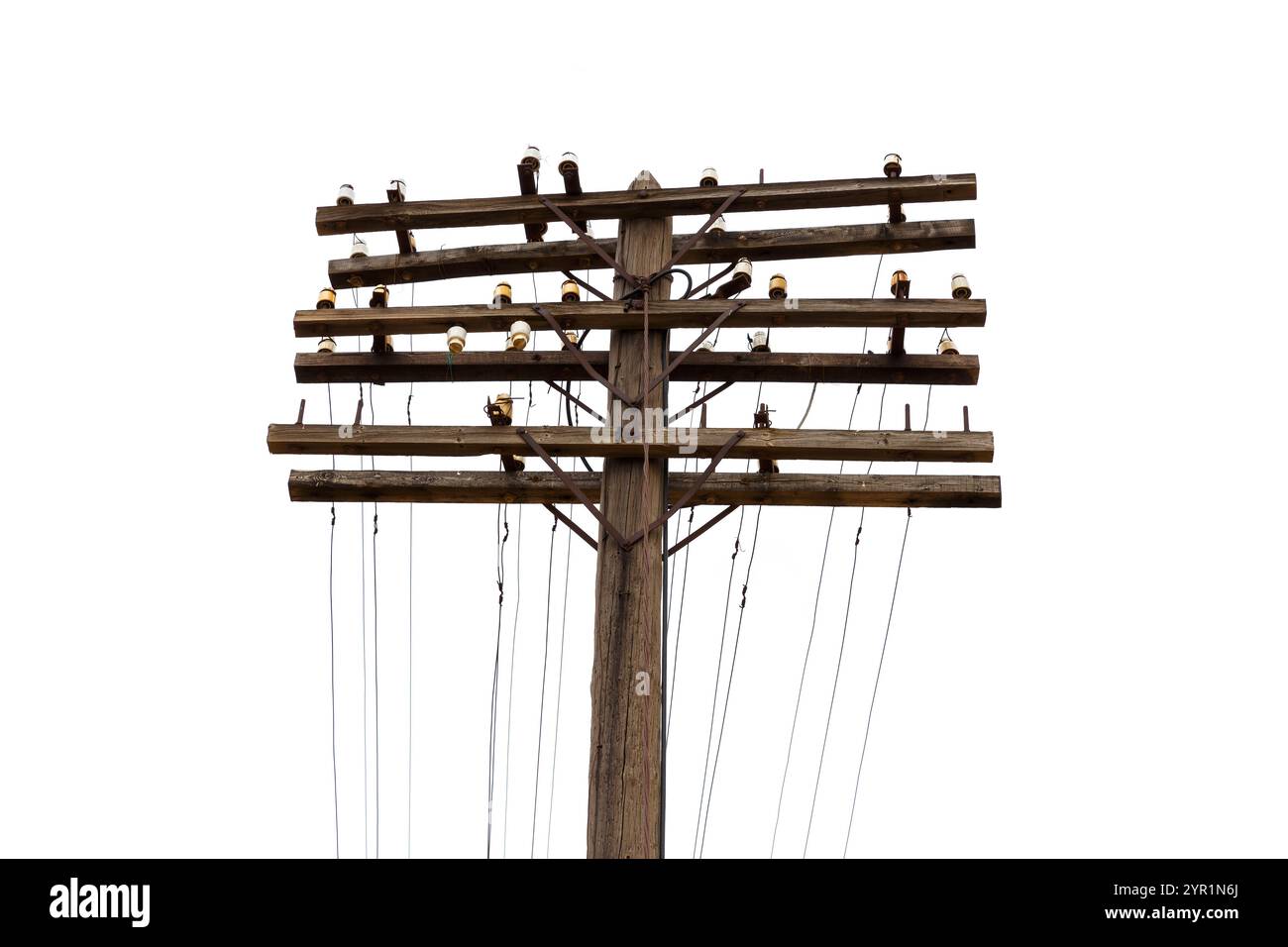Wooden utility poles support multiple rows of overhead communication ...