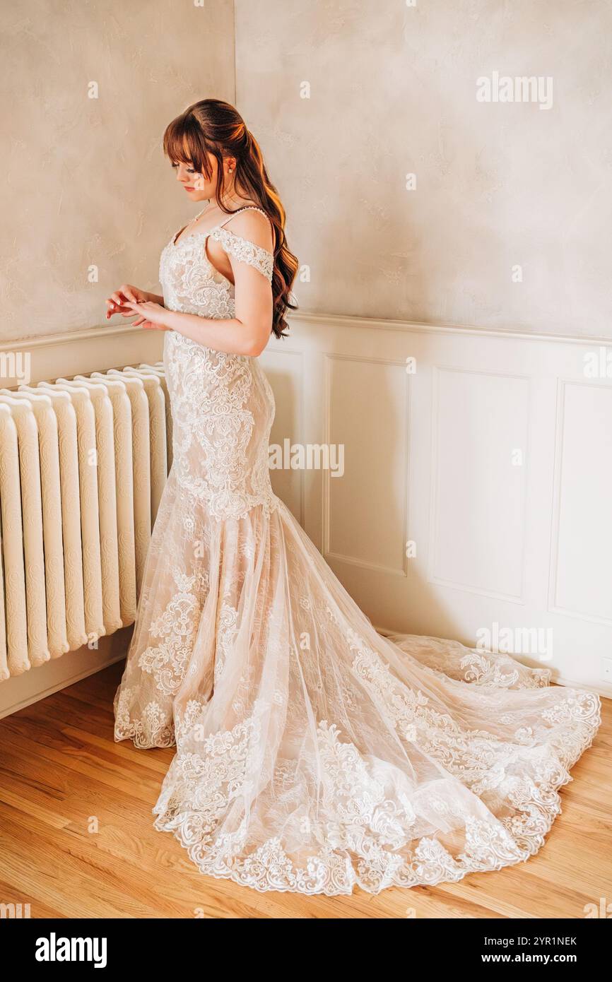 High key portrait of bride looking down at wedding ring Stock Photo - Alamy