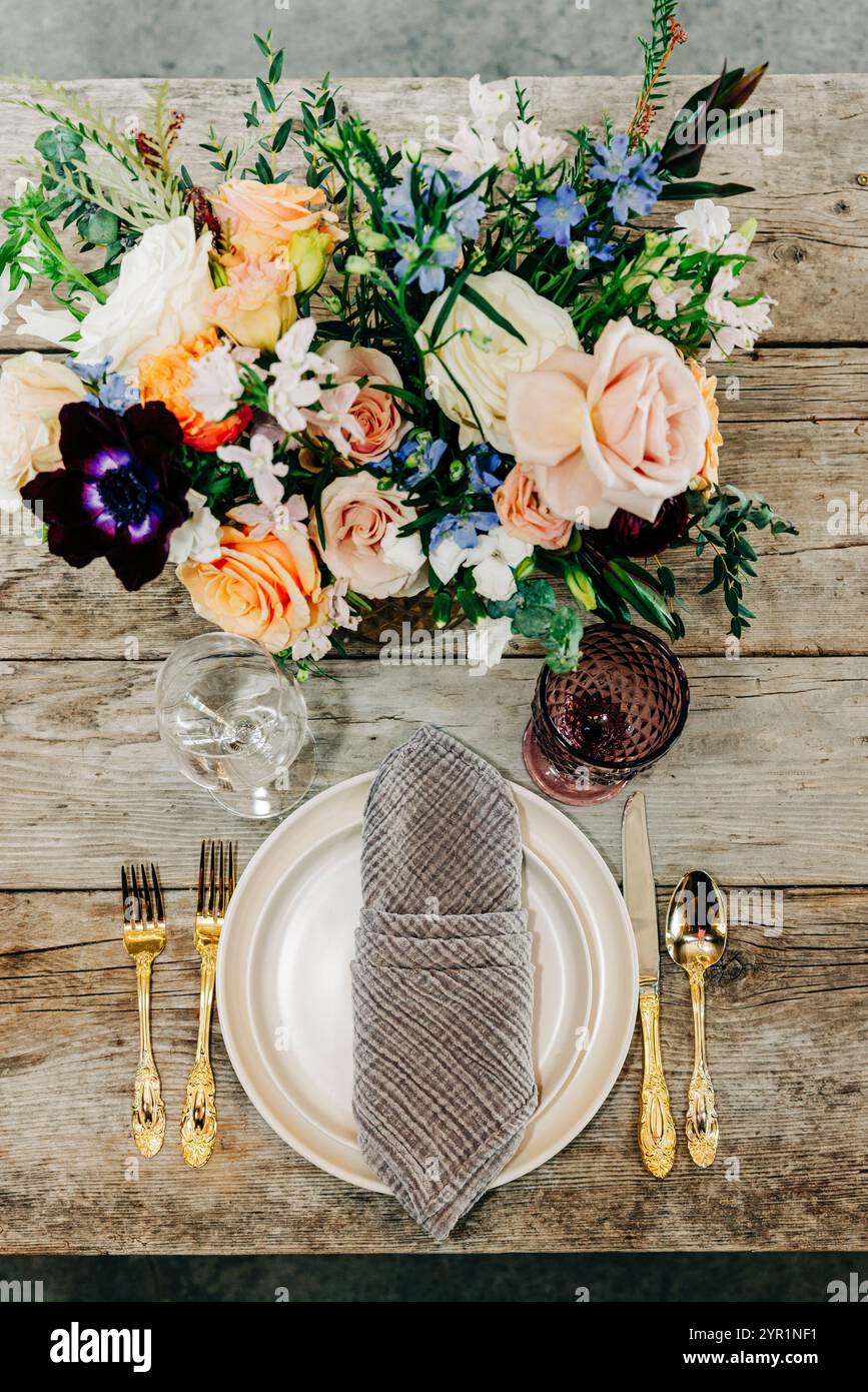 Rustic wedding tablescape with place setting and flower bouquet Stock ...