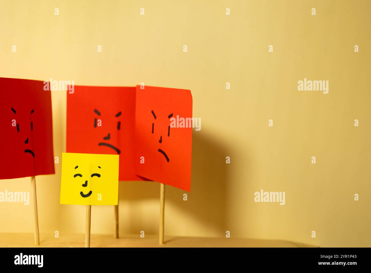 Horizontal image of yellow paper with smiling square face surrounded by ...