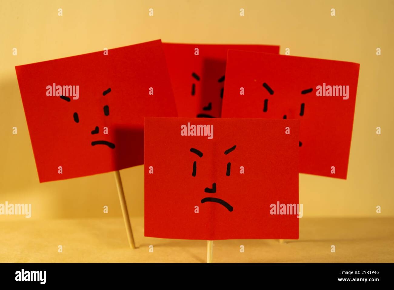 Group of red square papers with angry faces, group anger concept Stock ...