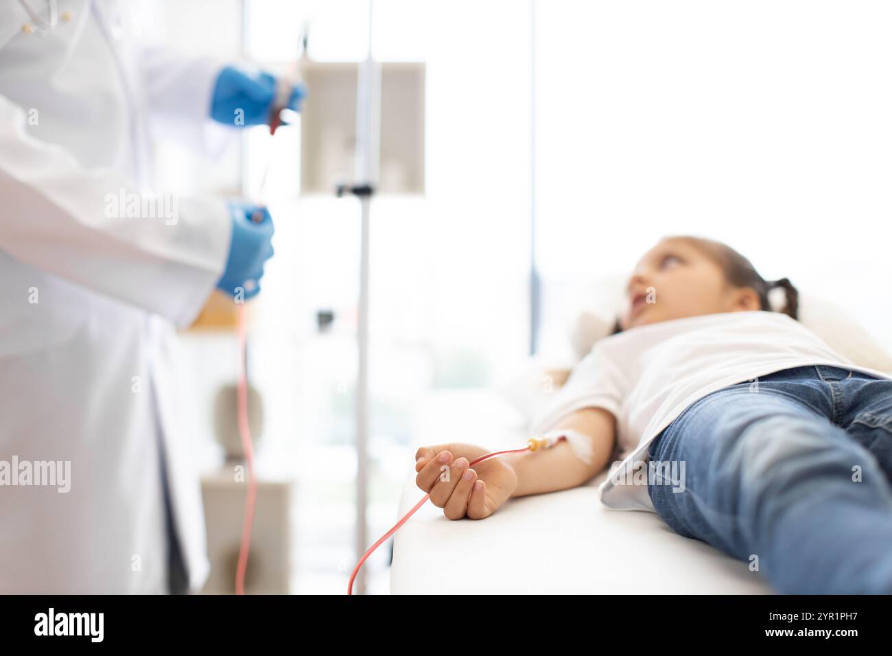 Young Caucasian girl receiving blood transfusion in hospital from ...