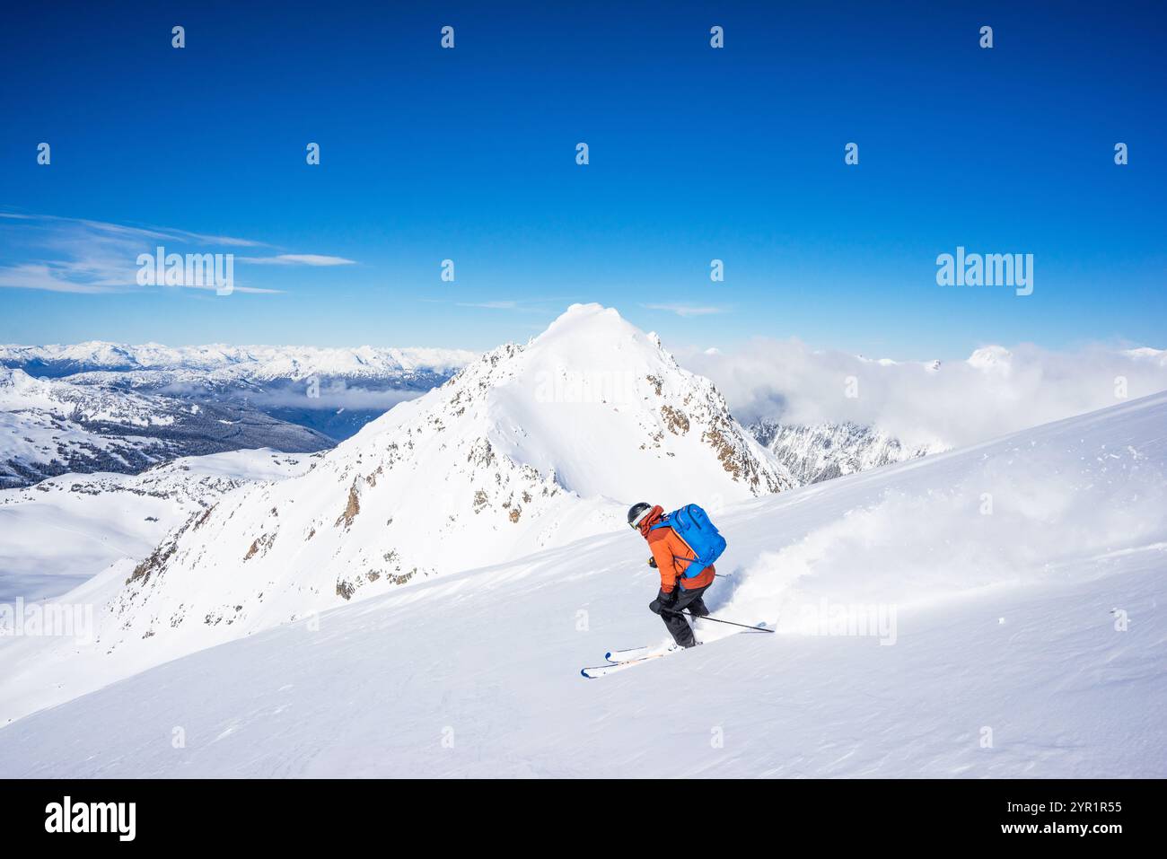 Side view of backcountry skier descending, stunning terrain, Whistler ...