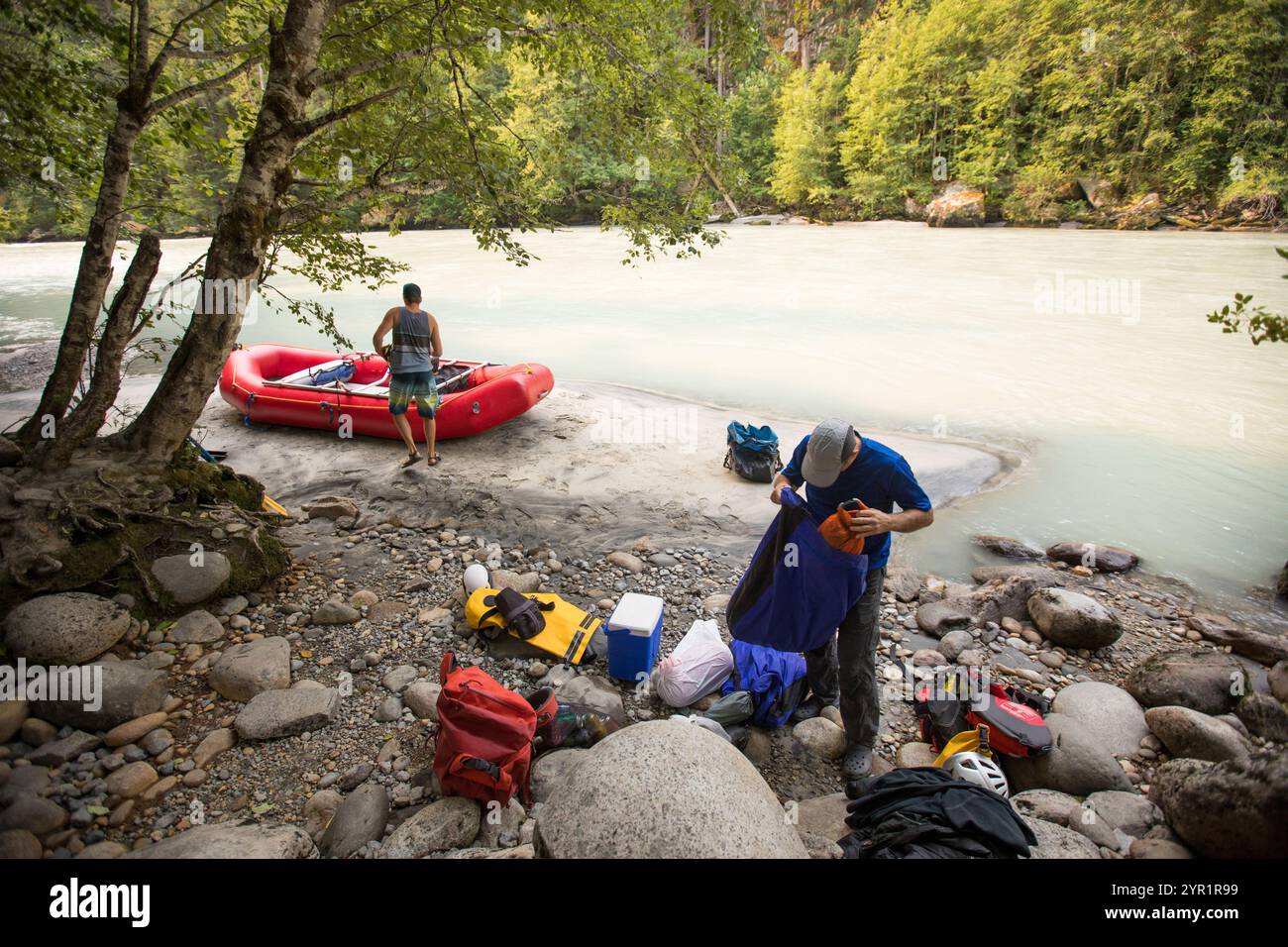 Two men prepare for a river rafting trip, sorting gear Stock Photo - Alamy
