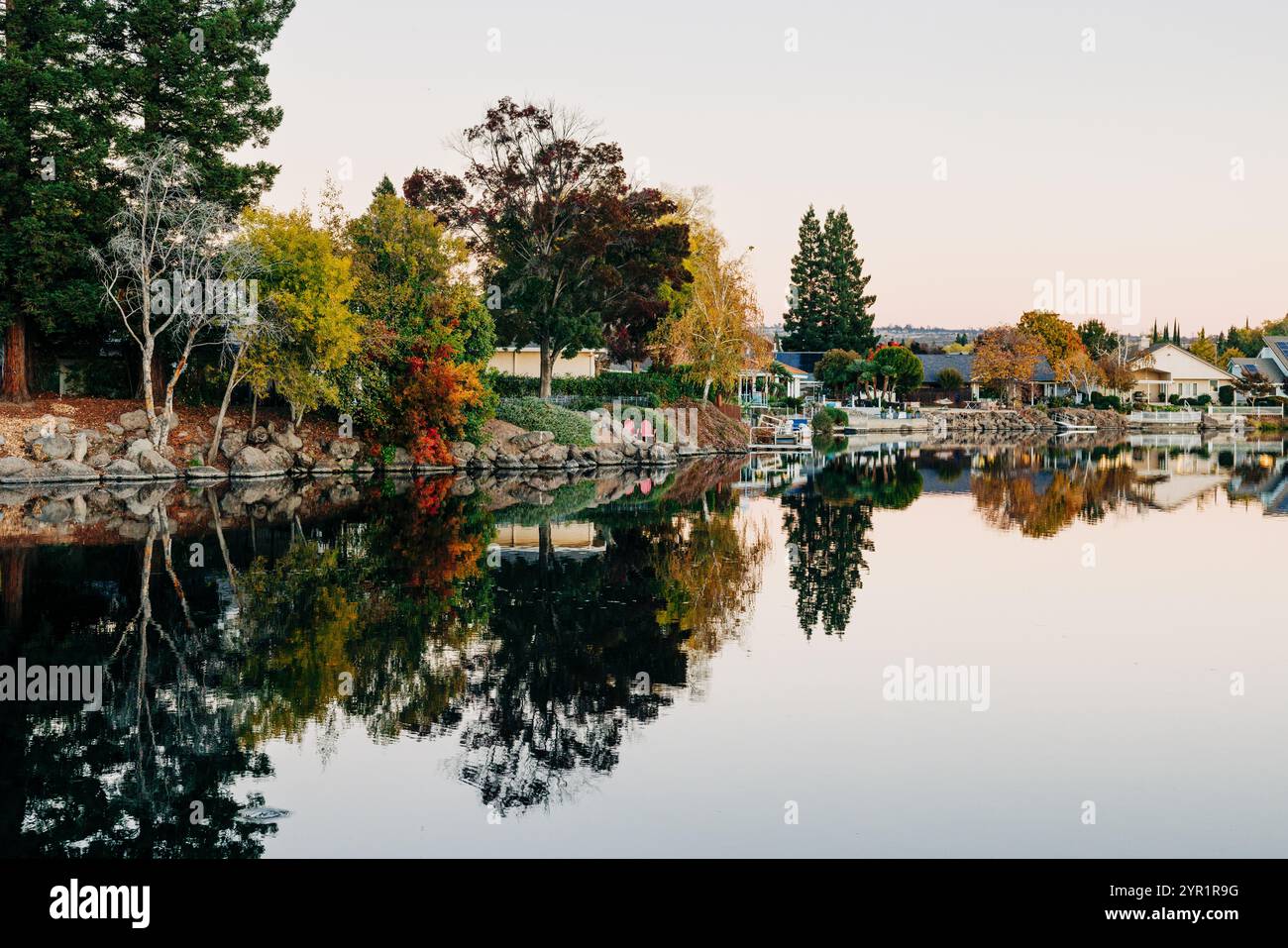 Fall waterfront scene with house and tree reflections Stock Photo - Alamy