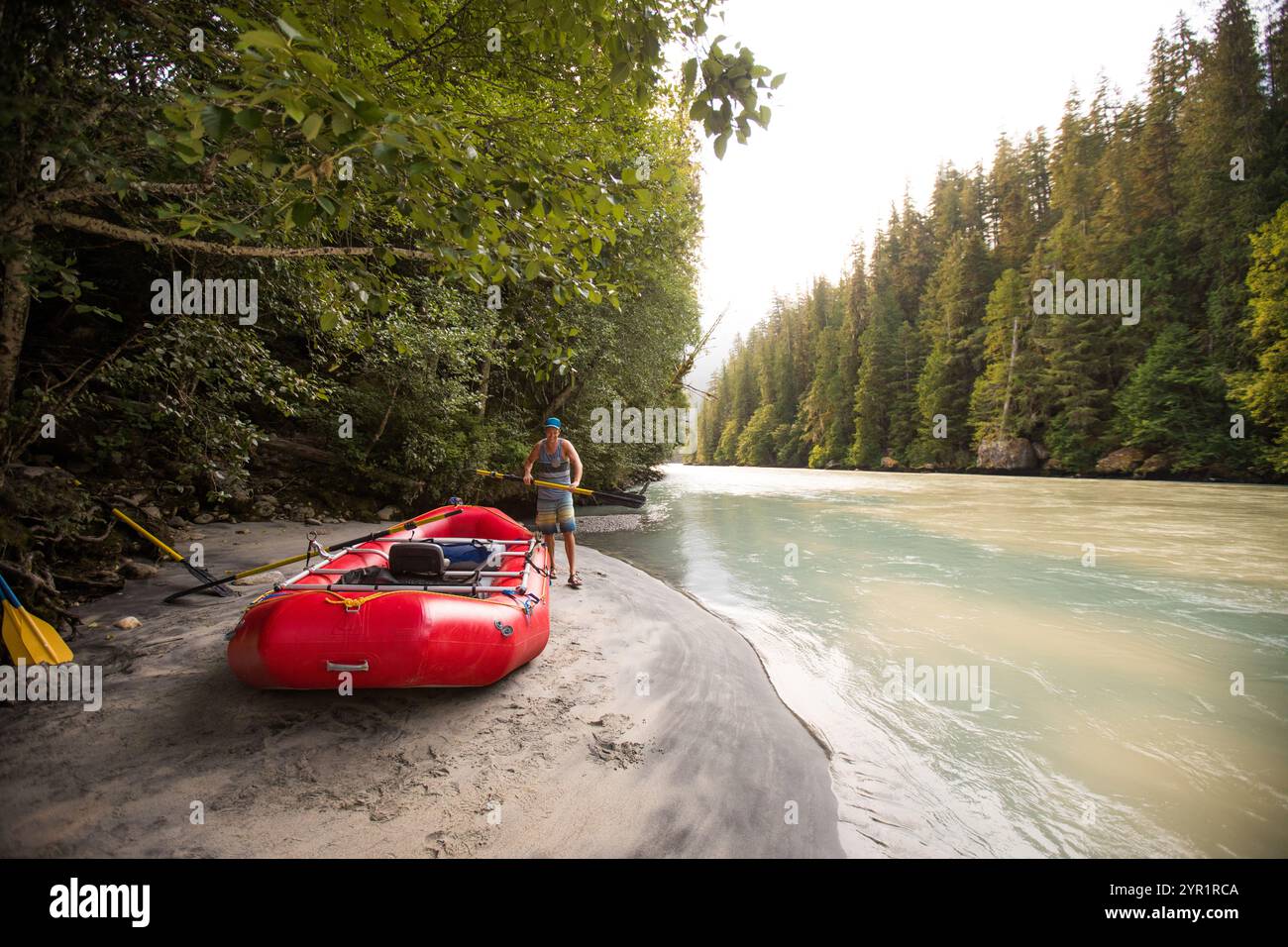 Man preparing raft, oars and gear before rafting down a river Stock ...