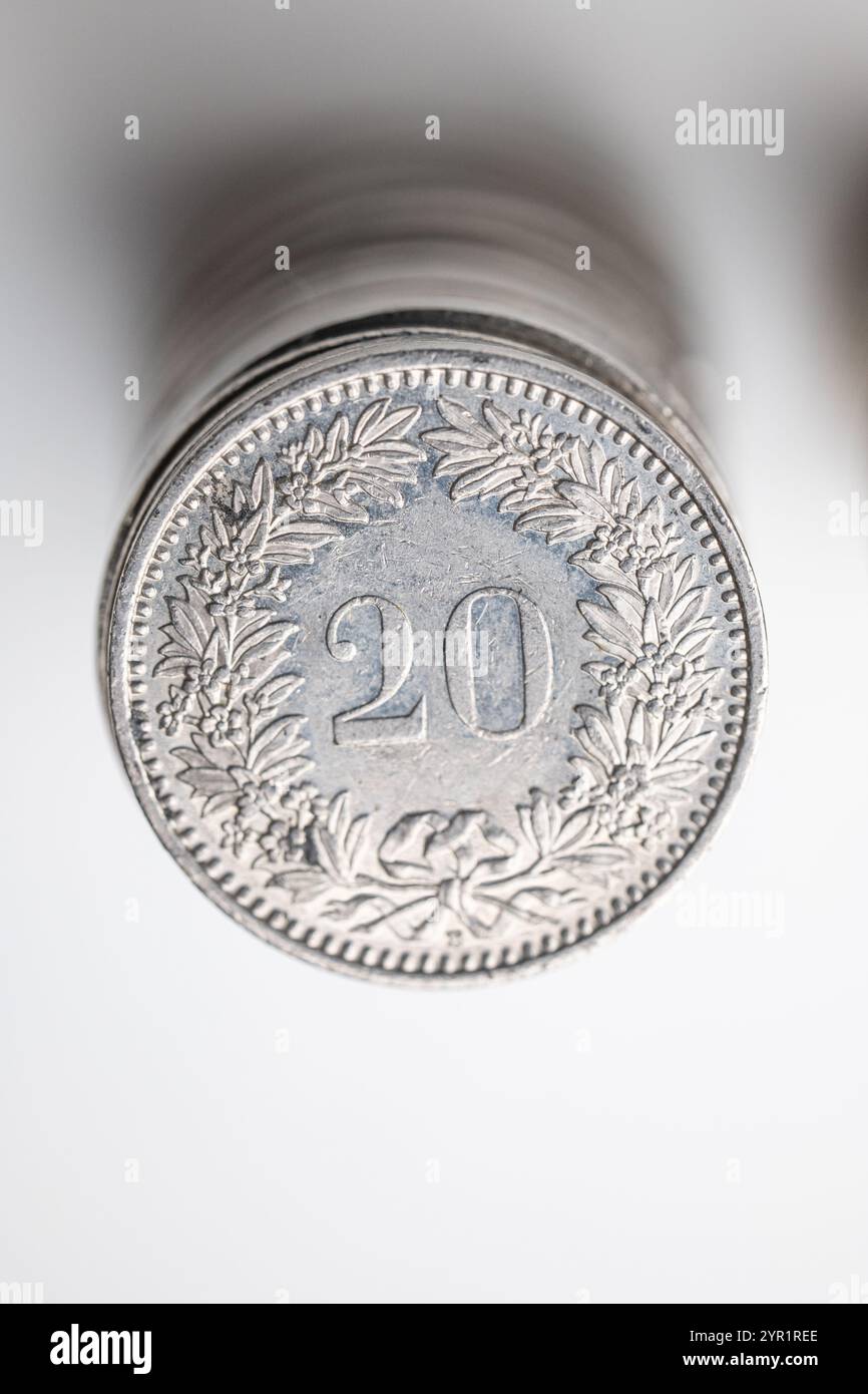 A stack of 20 Rappen Swiss Franc currency coins. Top view, isolated on ...