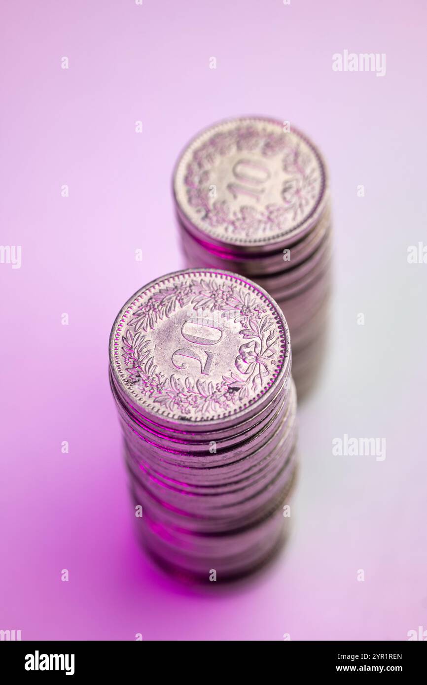 A stack of 20 Rappen and 10 Rappen Swiss Franc currency coins. Top view ...