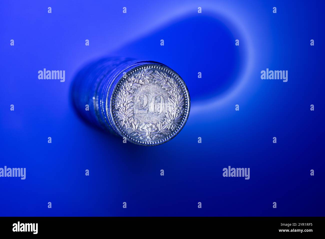 A stack of 20 Rappen Swiss Franc currency coins. Top view, isolated on ...