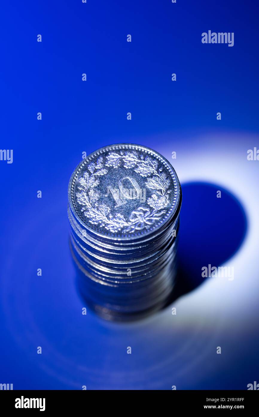 A stack of 10 Rappen Swiss Franc currency coins. Top view, isolated on ...