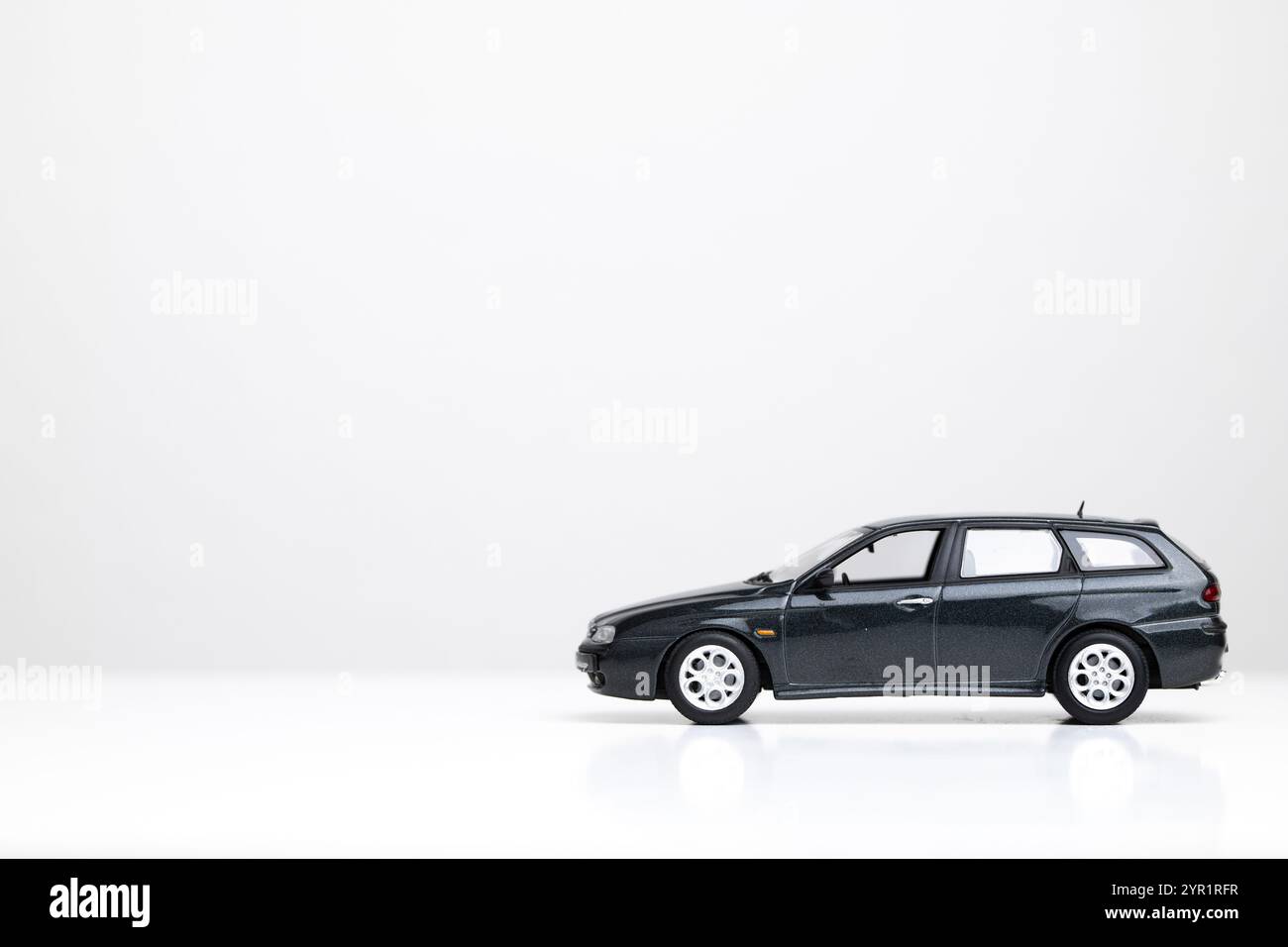 Small metal toy model car isolated on white. Close up shot, side ...