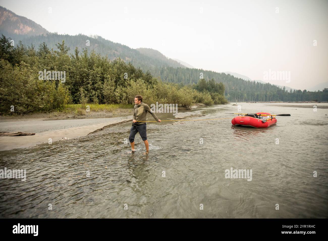 Rafting guide walks his raft up a shallow river channel Stock Photo - Alamy