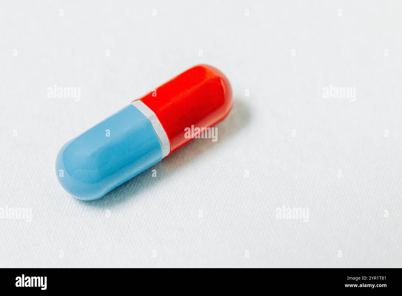 Close up of single red and blue capsule on white background Stock Photo ...