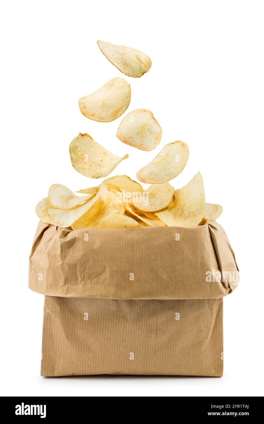 Potato chips falling into paper bag, on white background Stock Photo ...