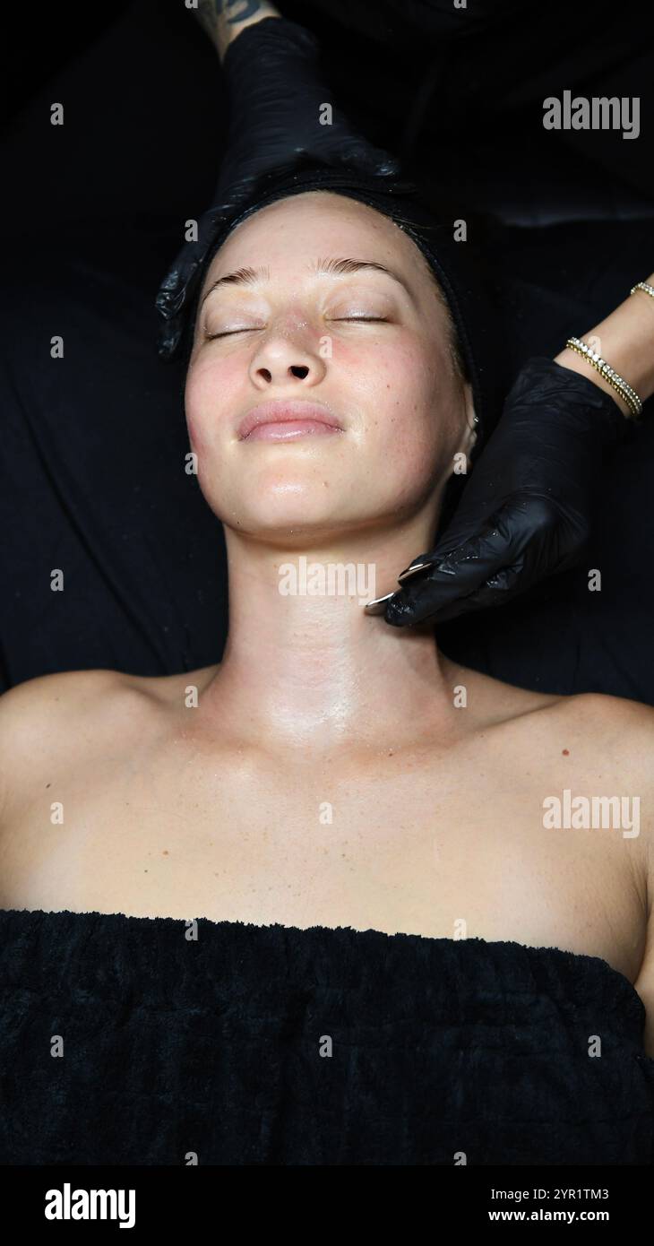 Woman receiving a gentle gua sha neck massage for relaxation Stock ...