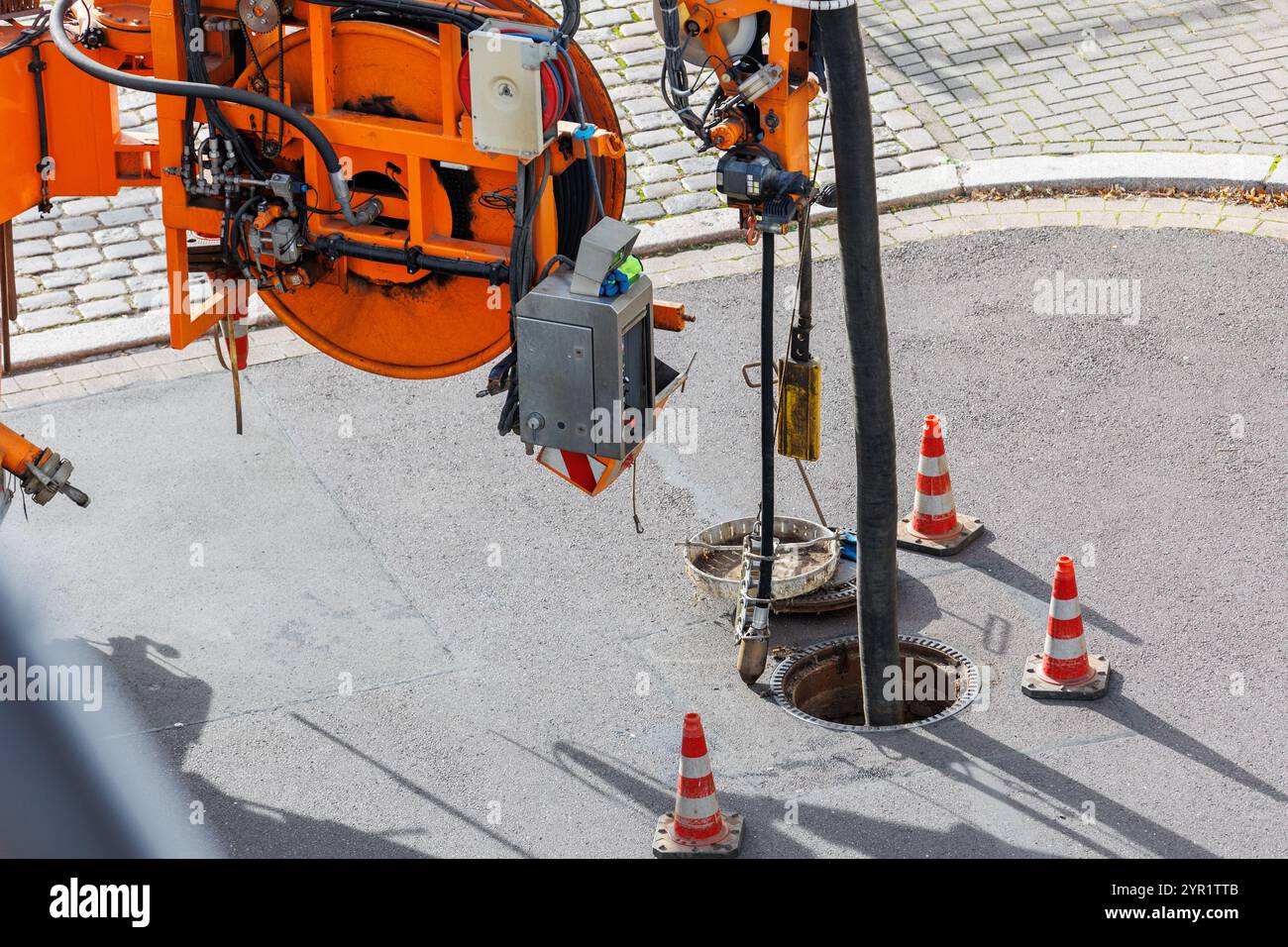 Pipe hose sewage truck car engine emptying city street sewerage manhole ...